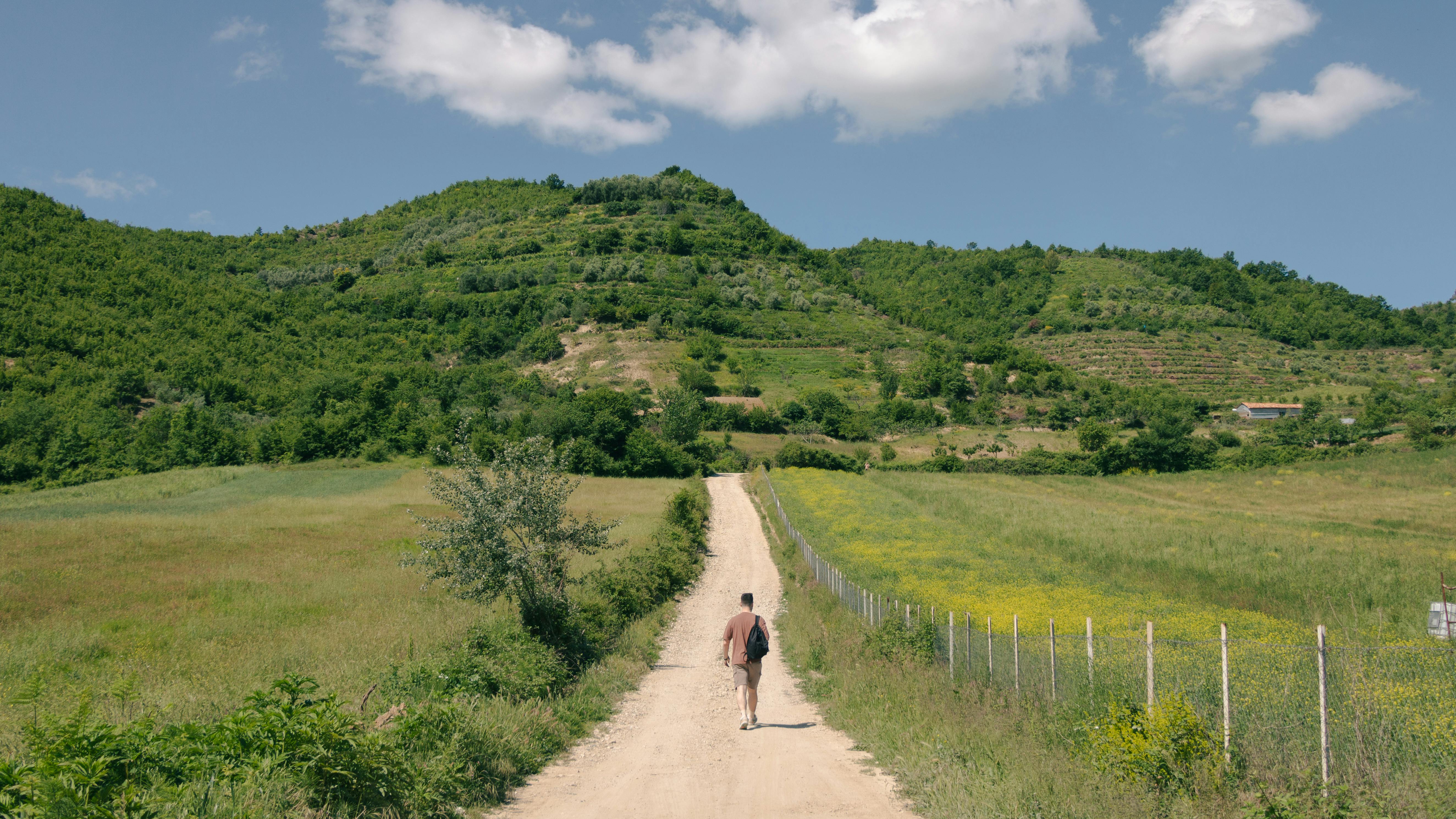 Man Walking Country Road · Free Stock Photo