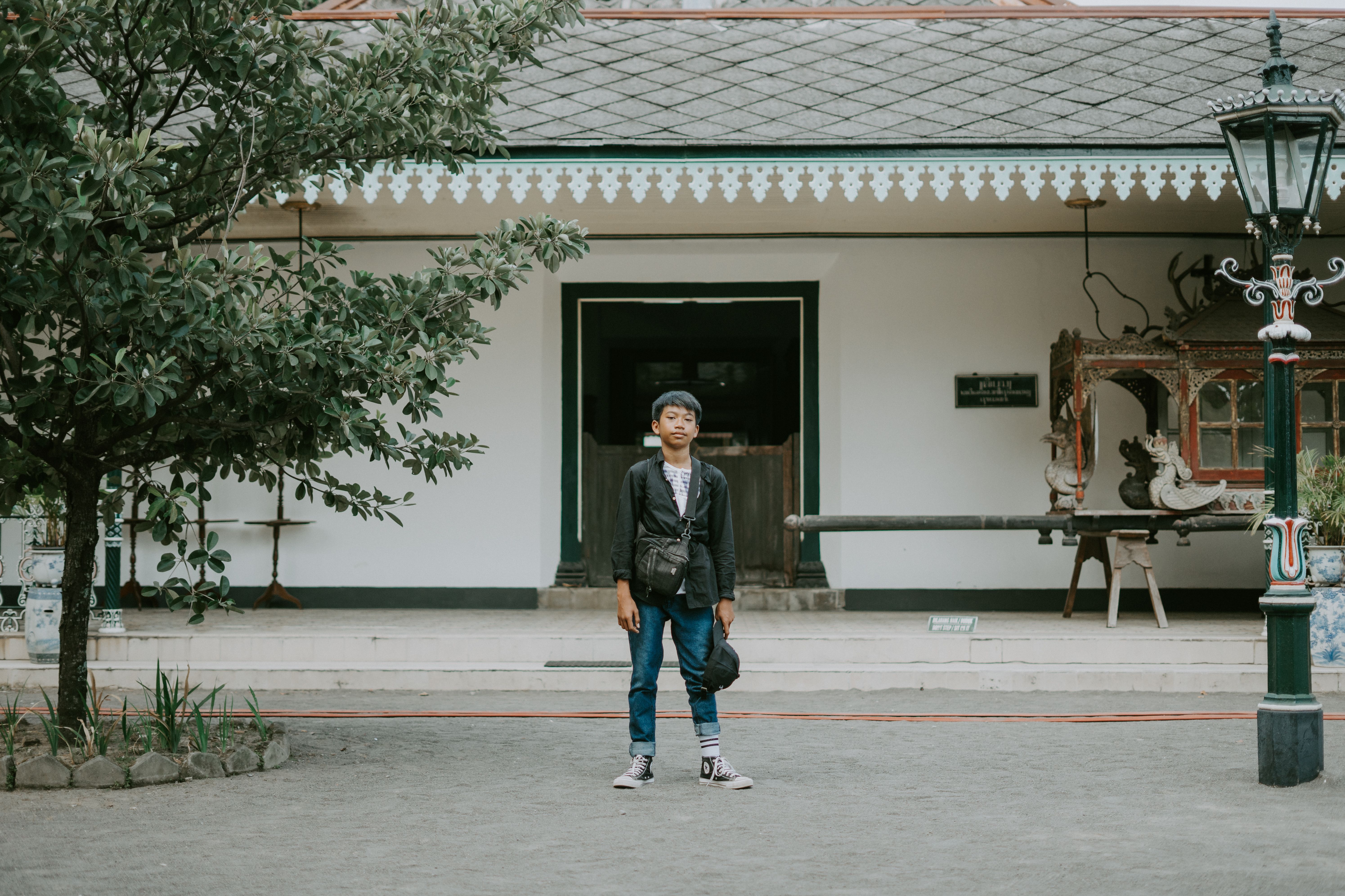 Person Standing In Front Of A Building · Free Stock Photo