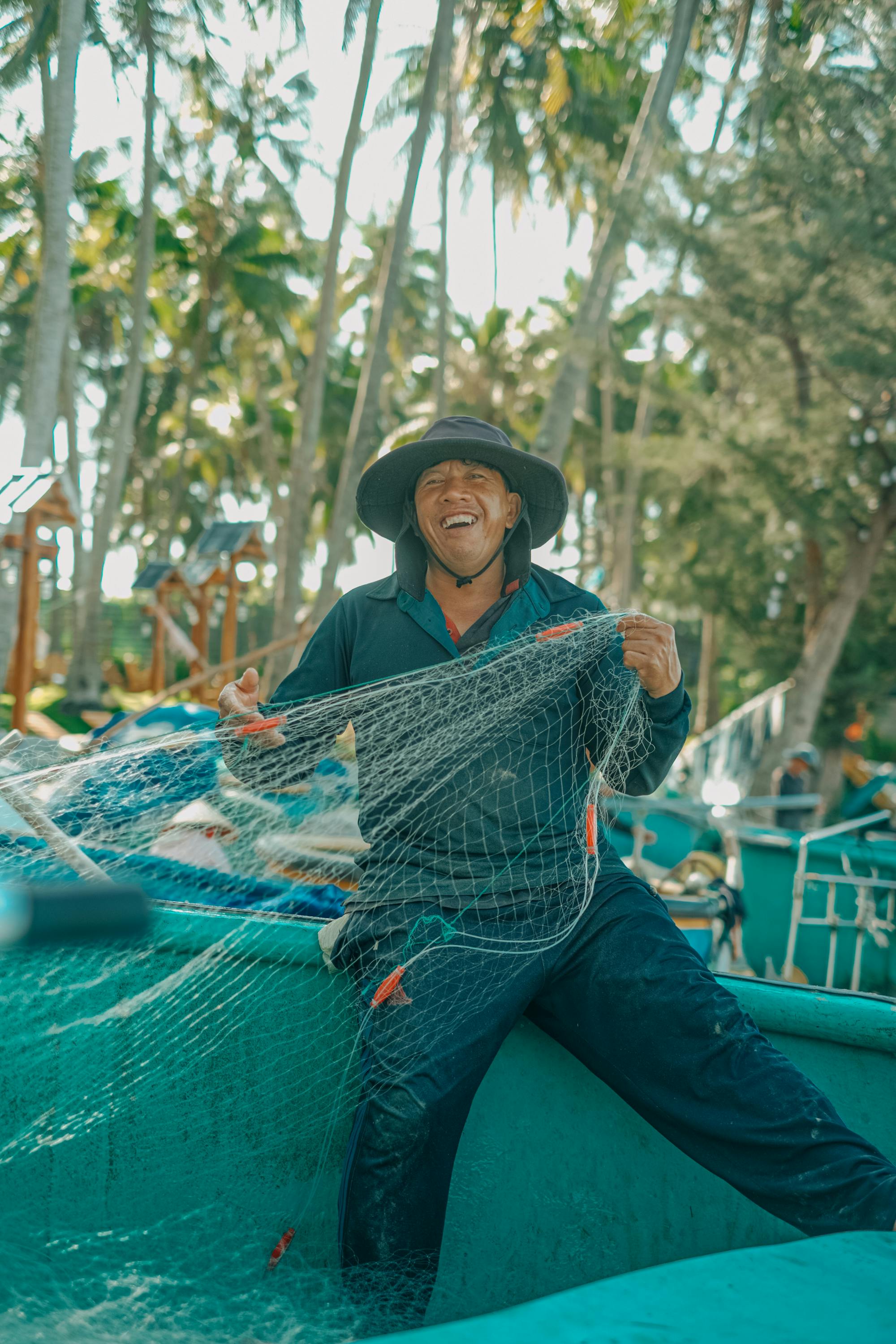 Fisherman Holding a Net · Free Stock Photo