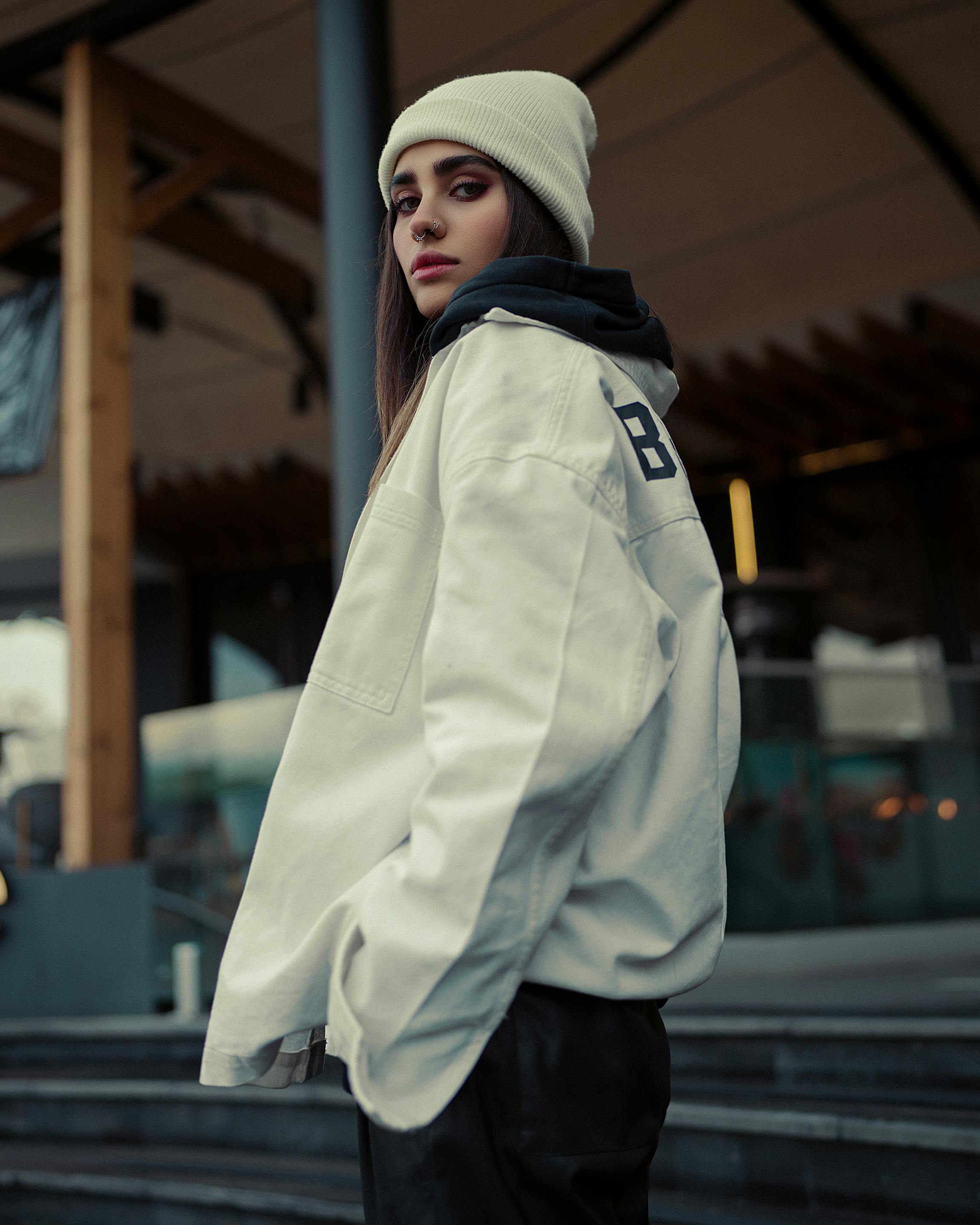 Female Model Wearing a White Hoodie and a Knit Hat · Free Stock Photo