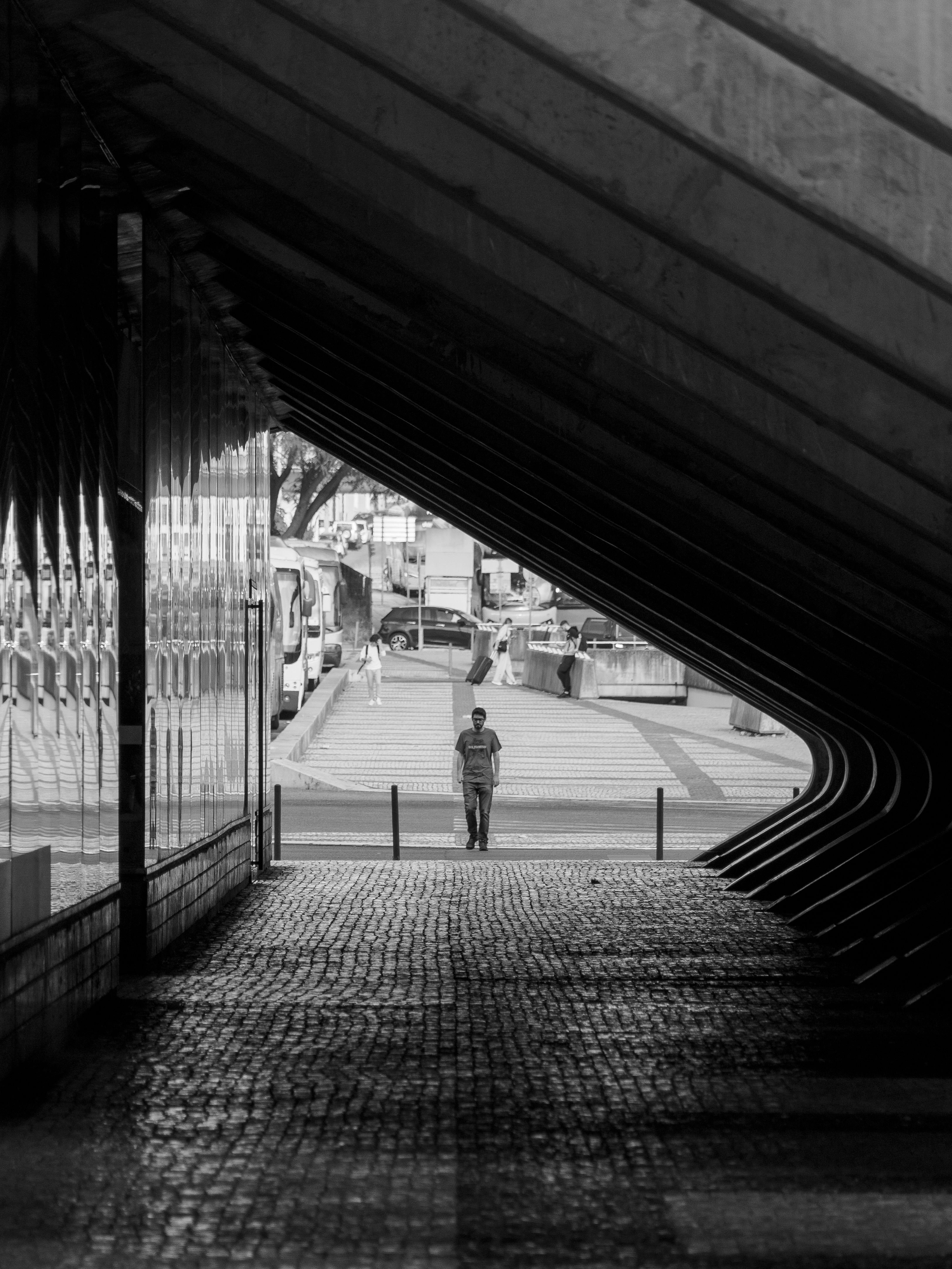 A person walking down a walkway in a tunnel · Free Stock Photo
