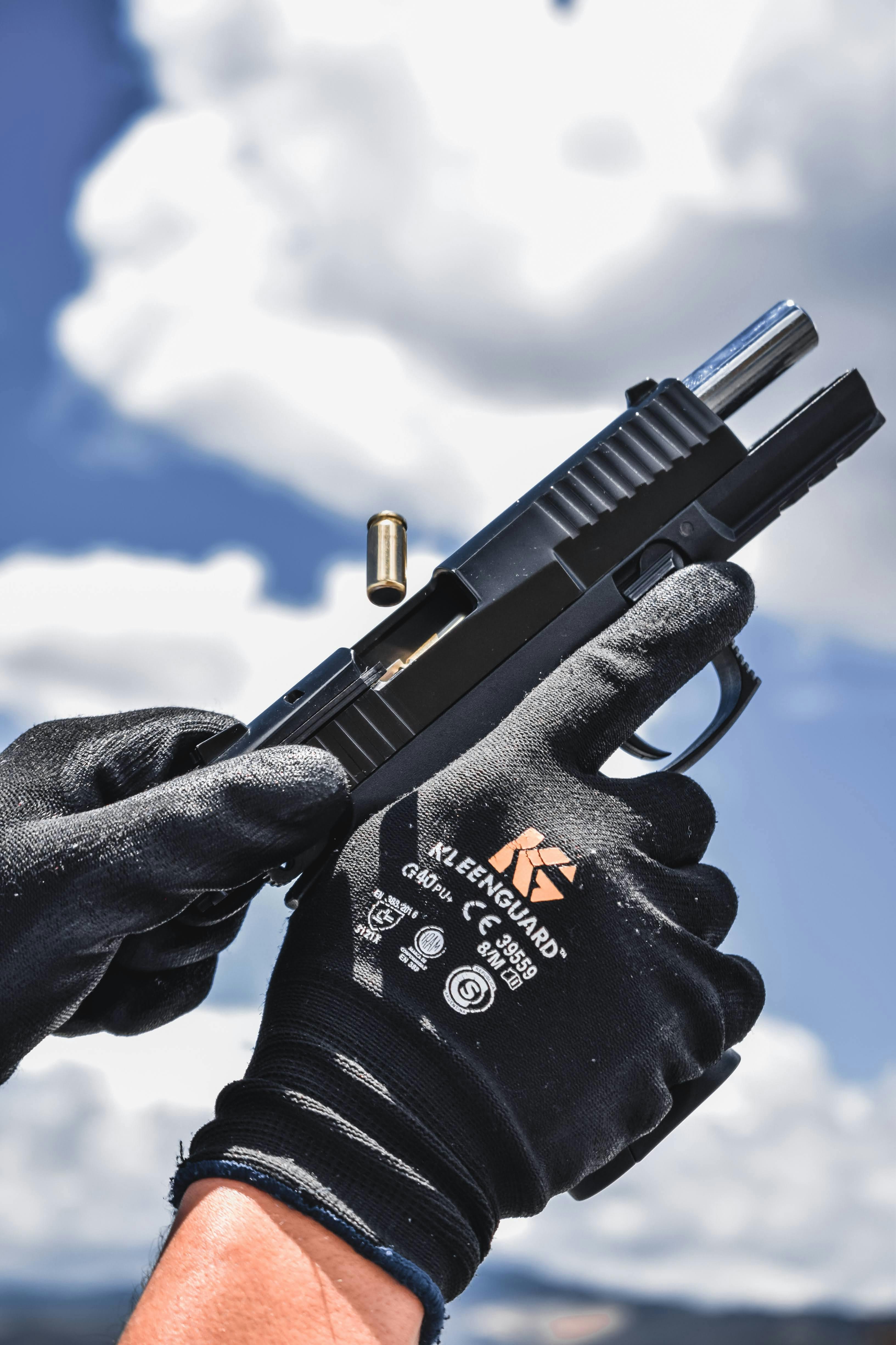 Close-up of a Man Reloading the Gun · Free Stock Photo