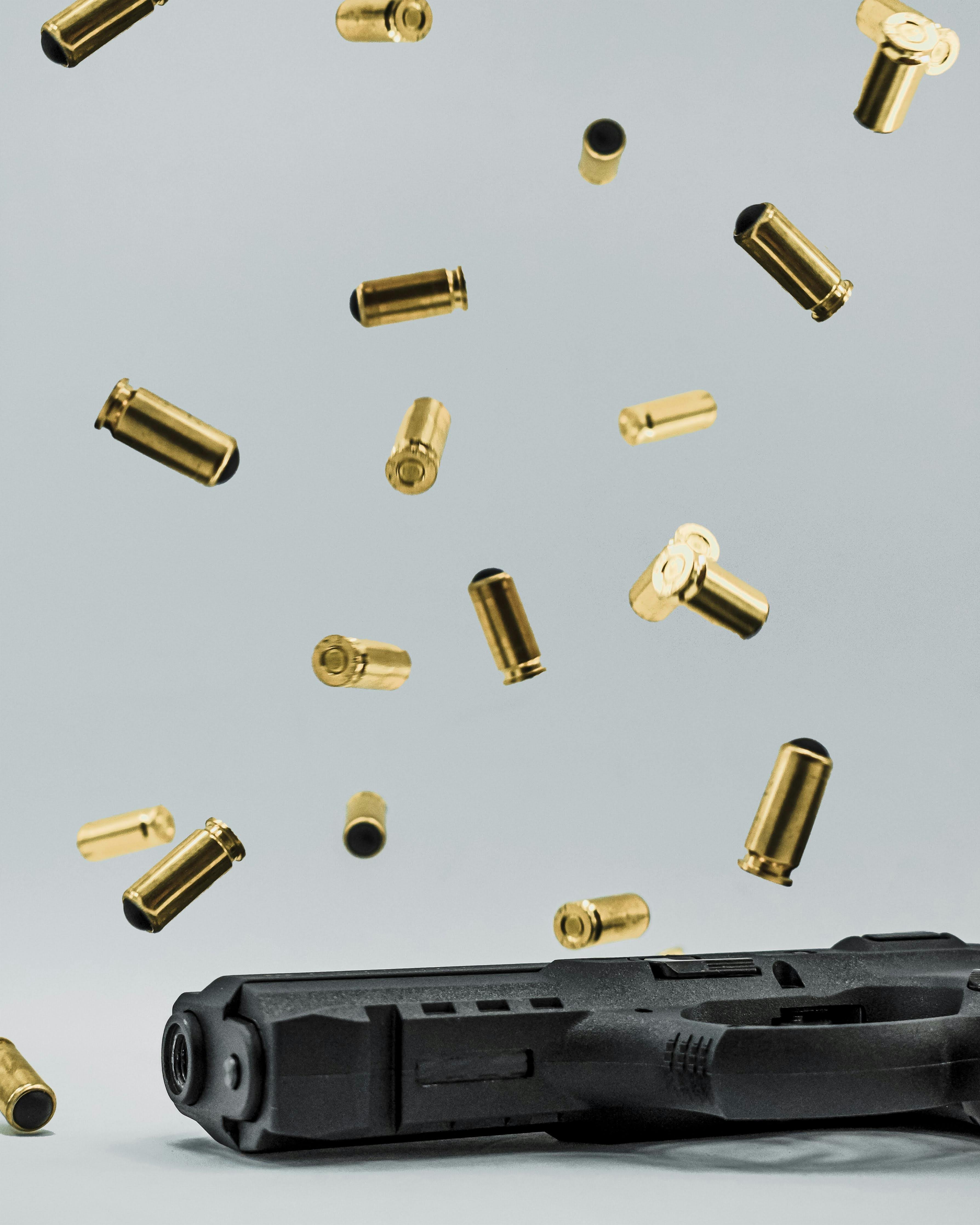 Bullets Flying around Pistol · Free Stock Photo