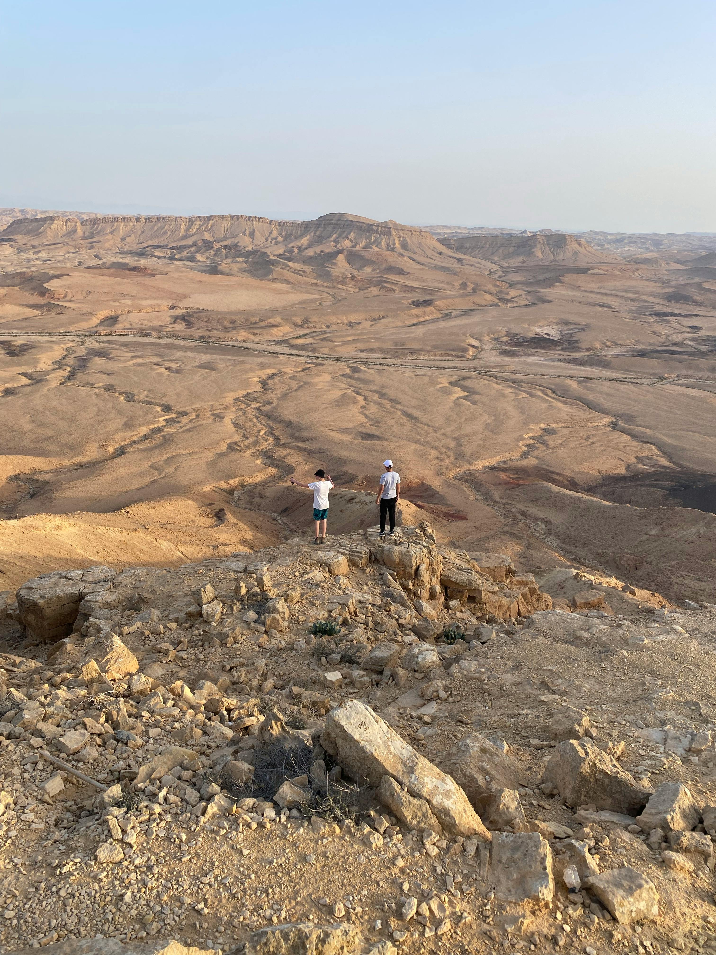 Men on Rocks by the Desert · Free Stock Photo