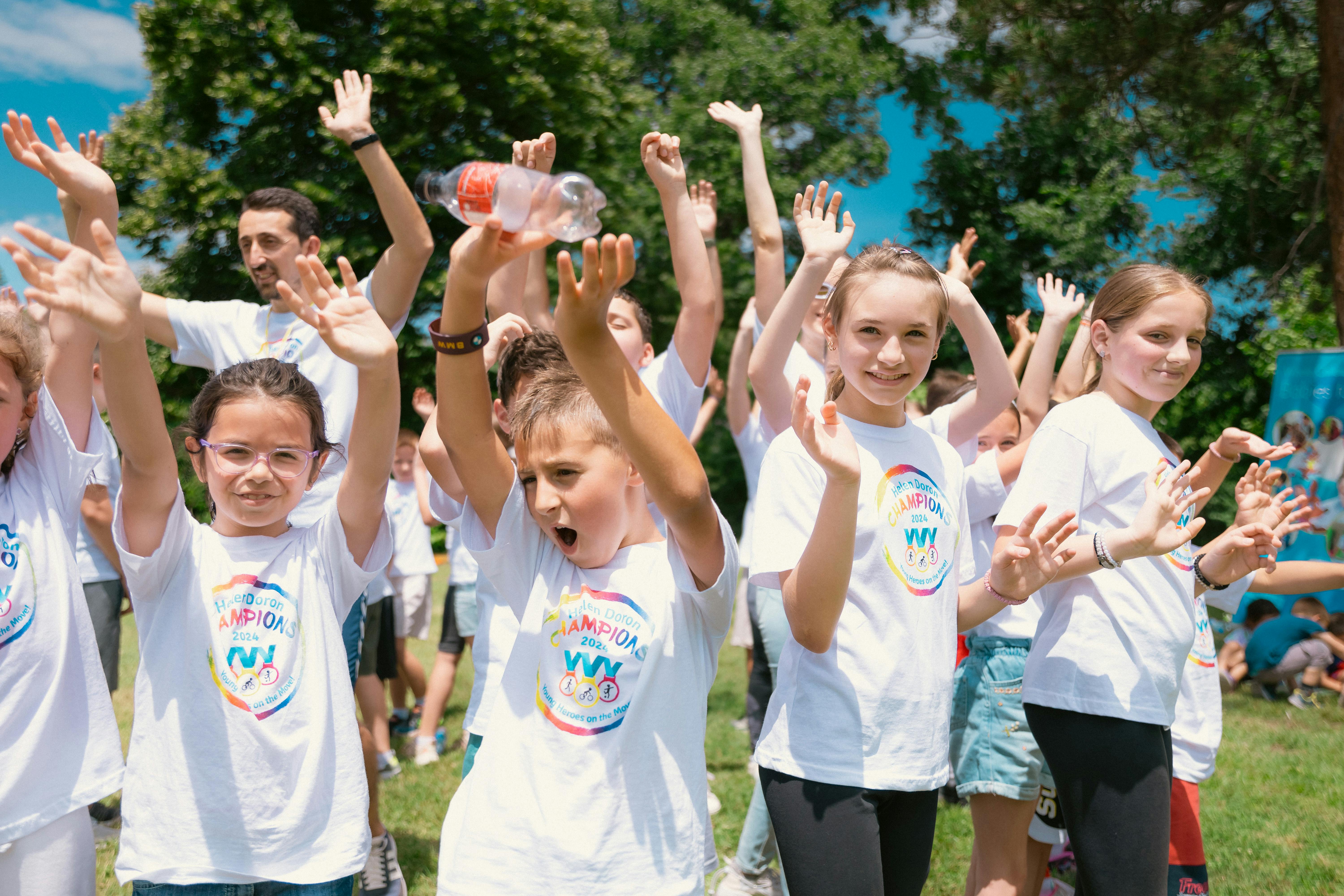 Kids Standing Together with Raised Arms during a Physical Education ...