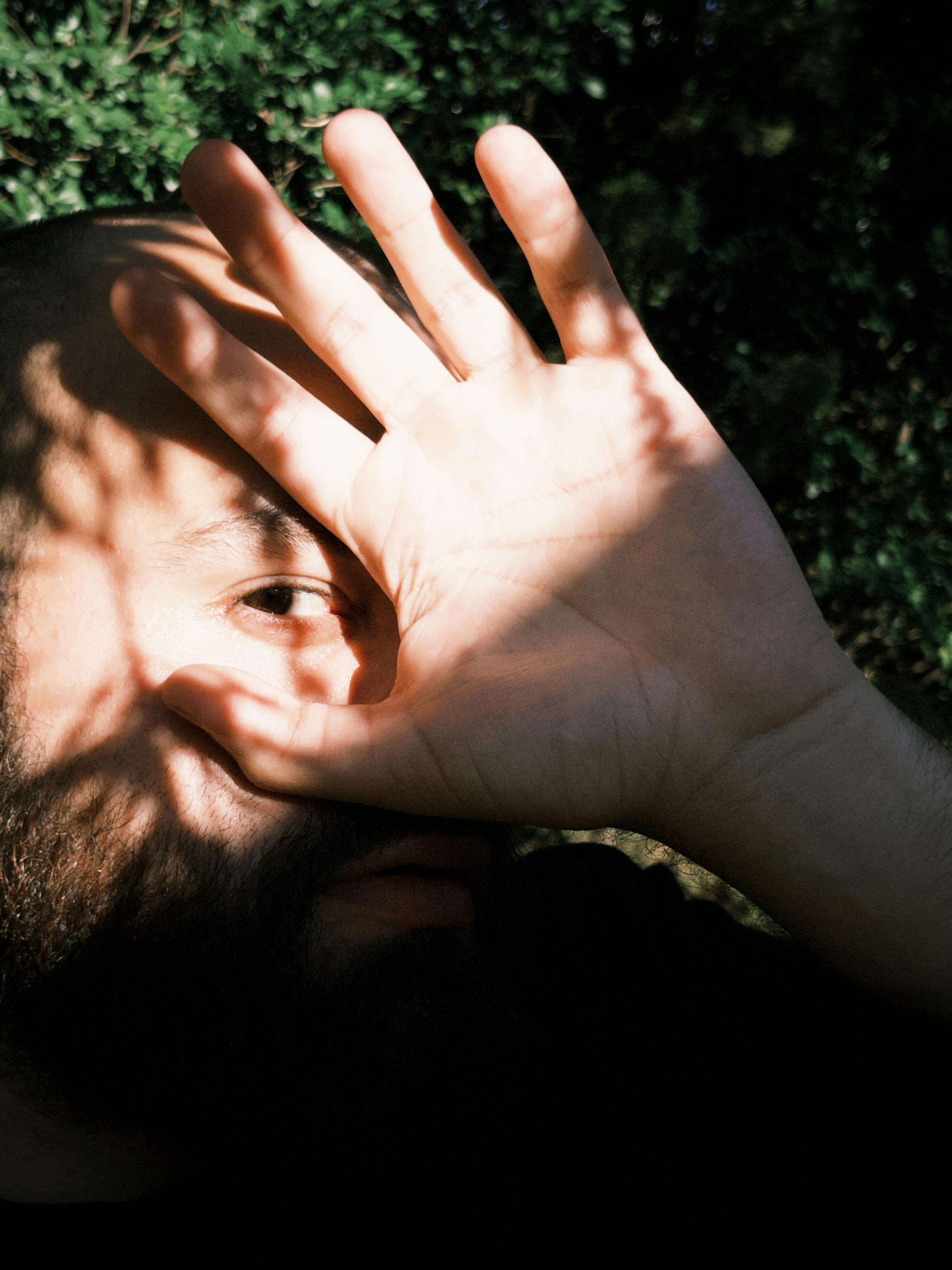 Man Covering His Face in Sunlight · Free Stock Photo