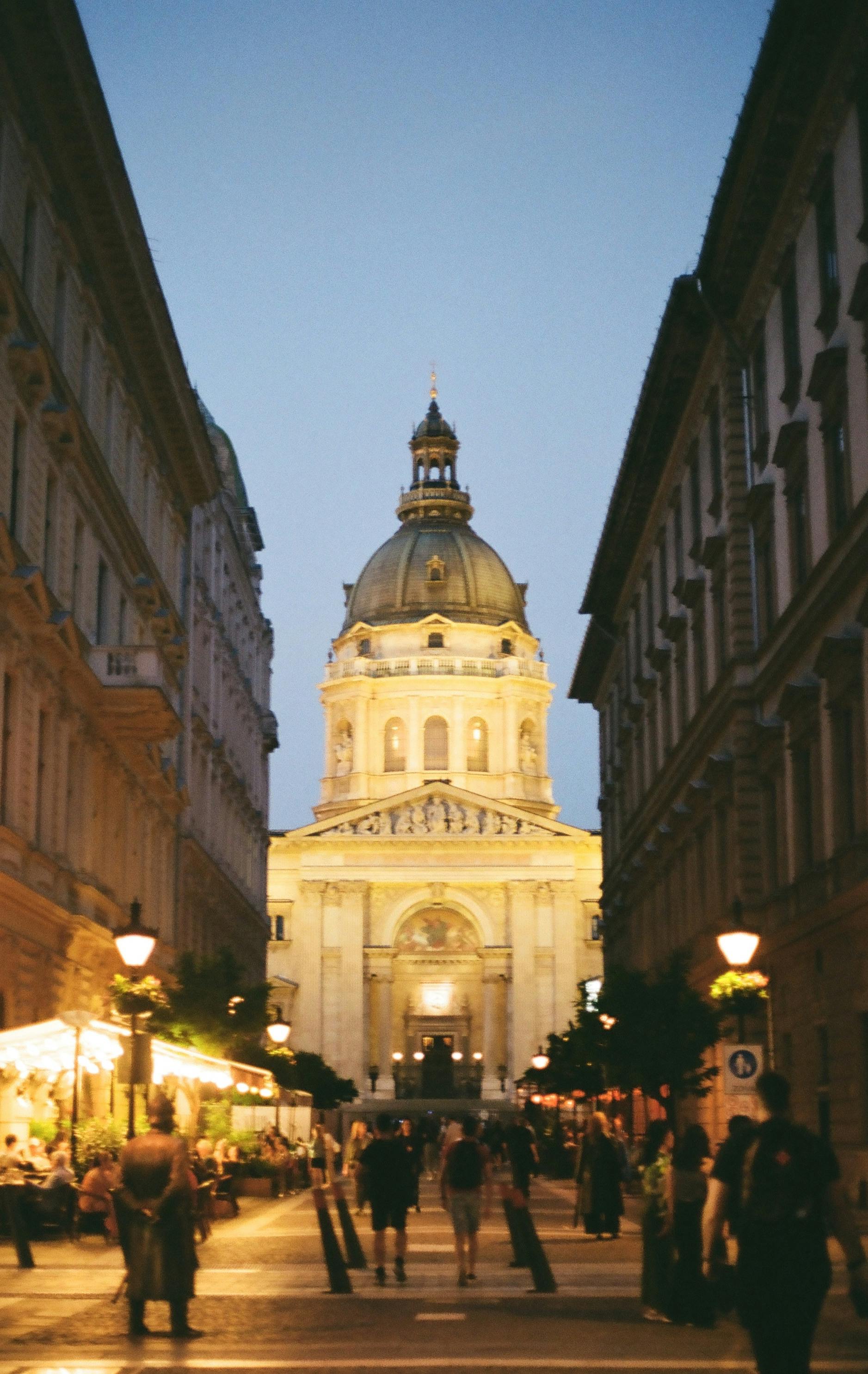 Pedestrians Walking on the Street with View of an Illuminated St ...