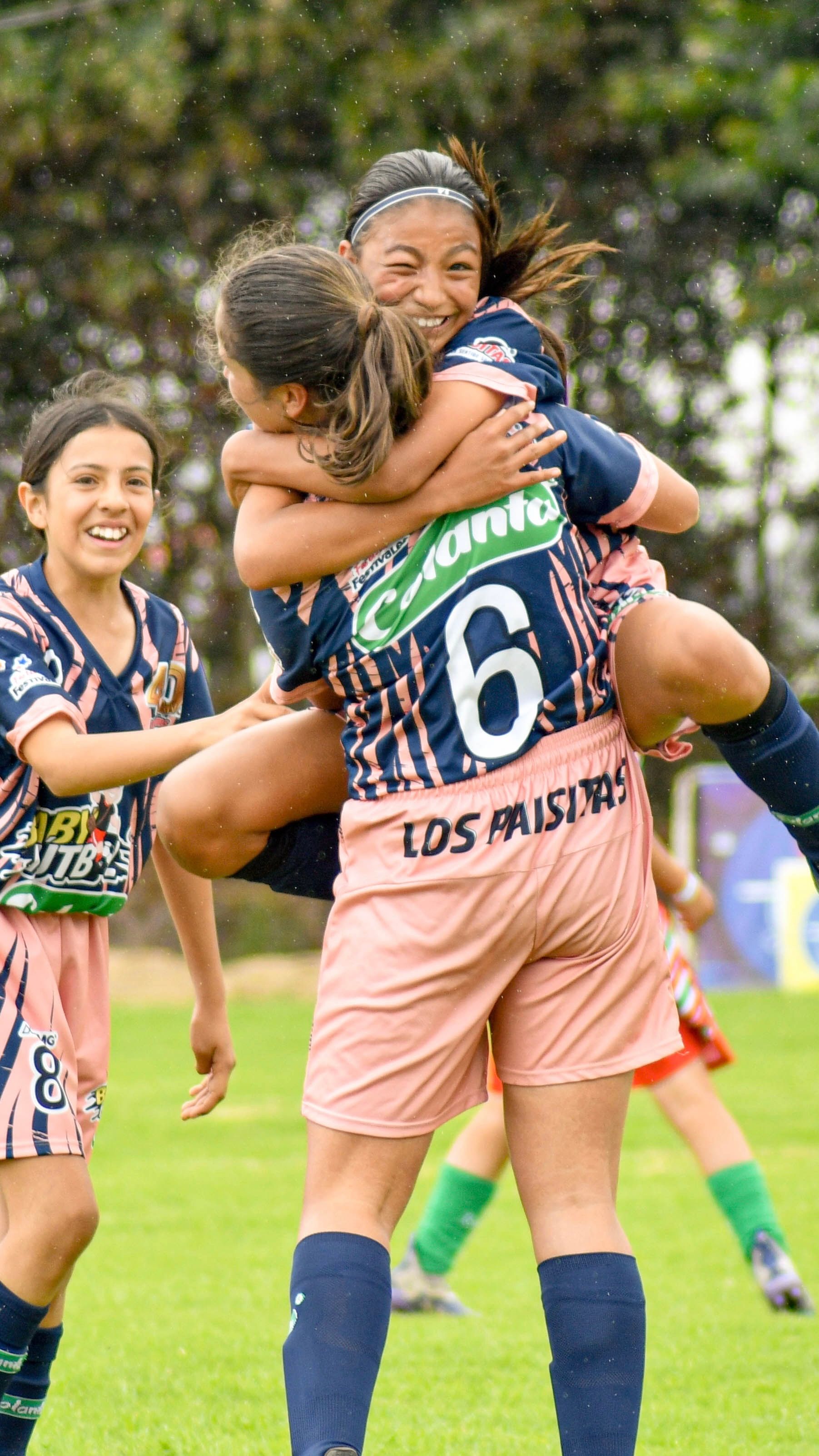 Girls Hugging on Soccer Field · Free Stock Photo