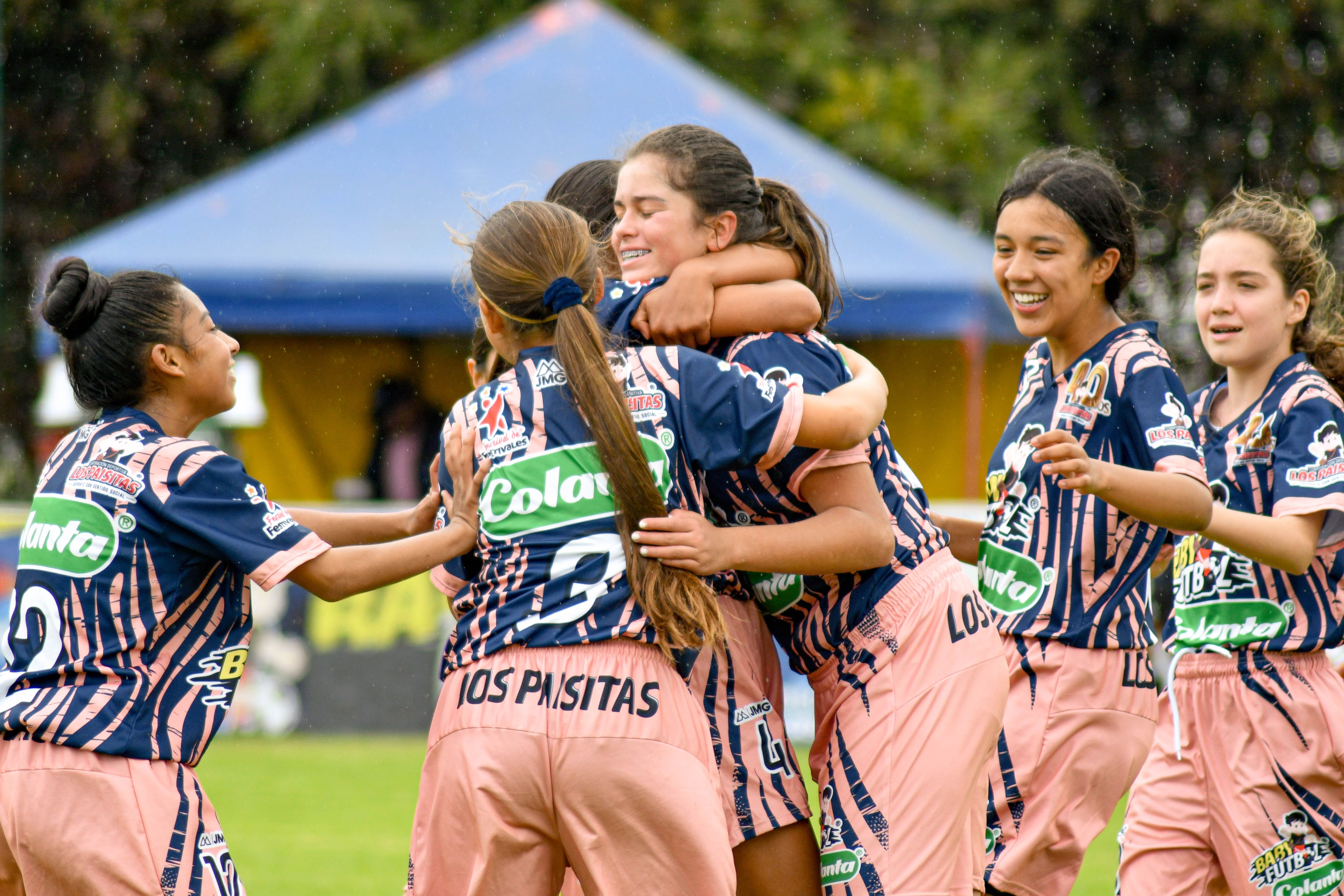 Smiling Girls Hugging at Soccer Field · Free Stock Photo