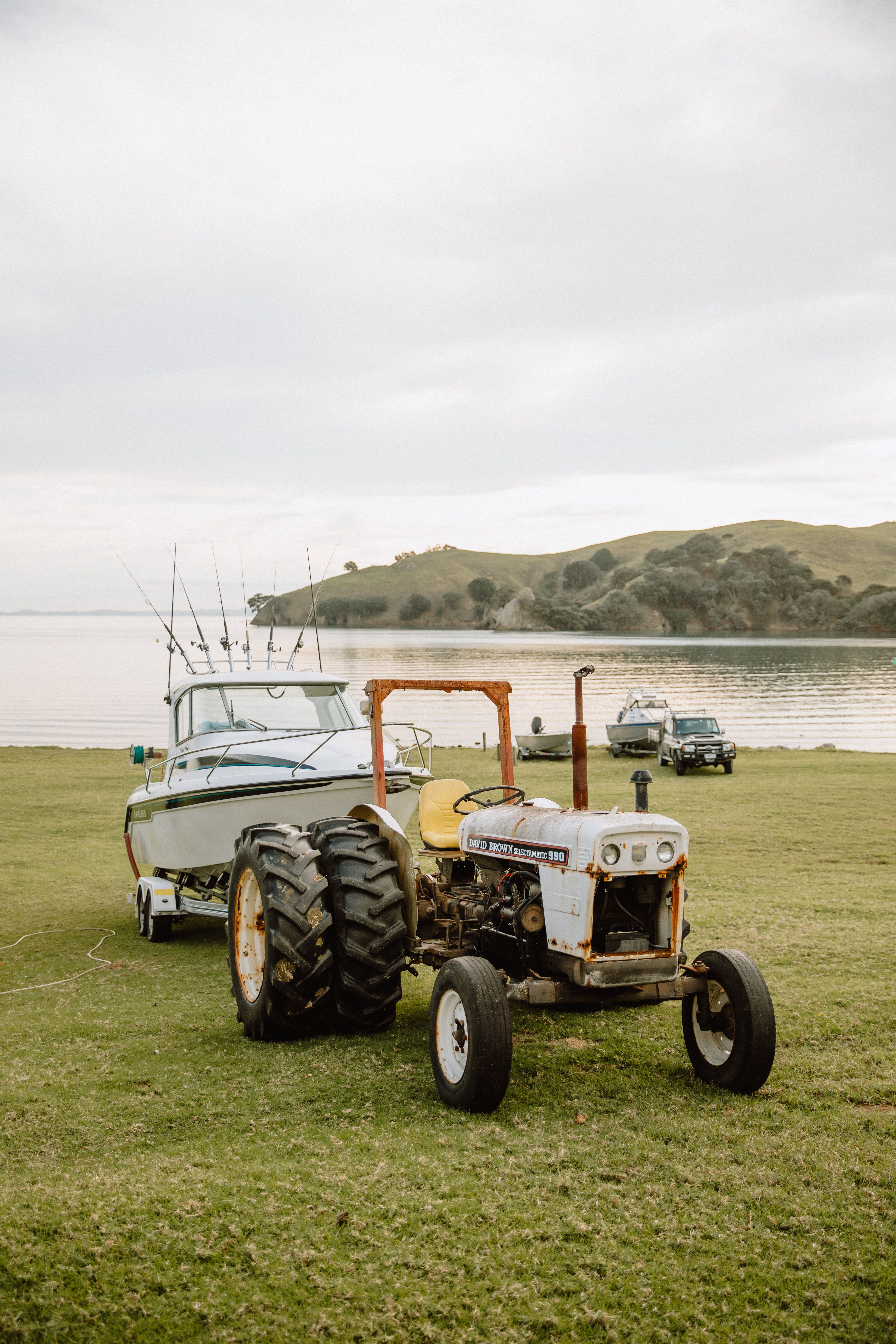 Tractor with Motorboat on Trailer on Sea Coast · Free Stock Photo