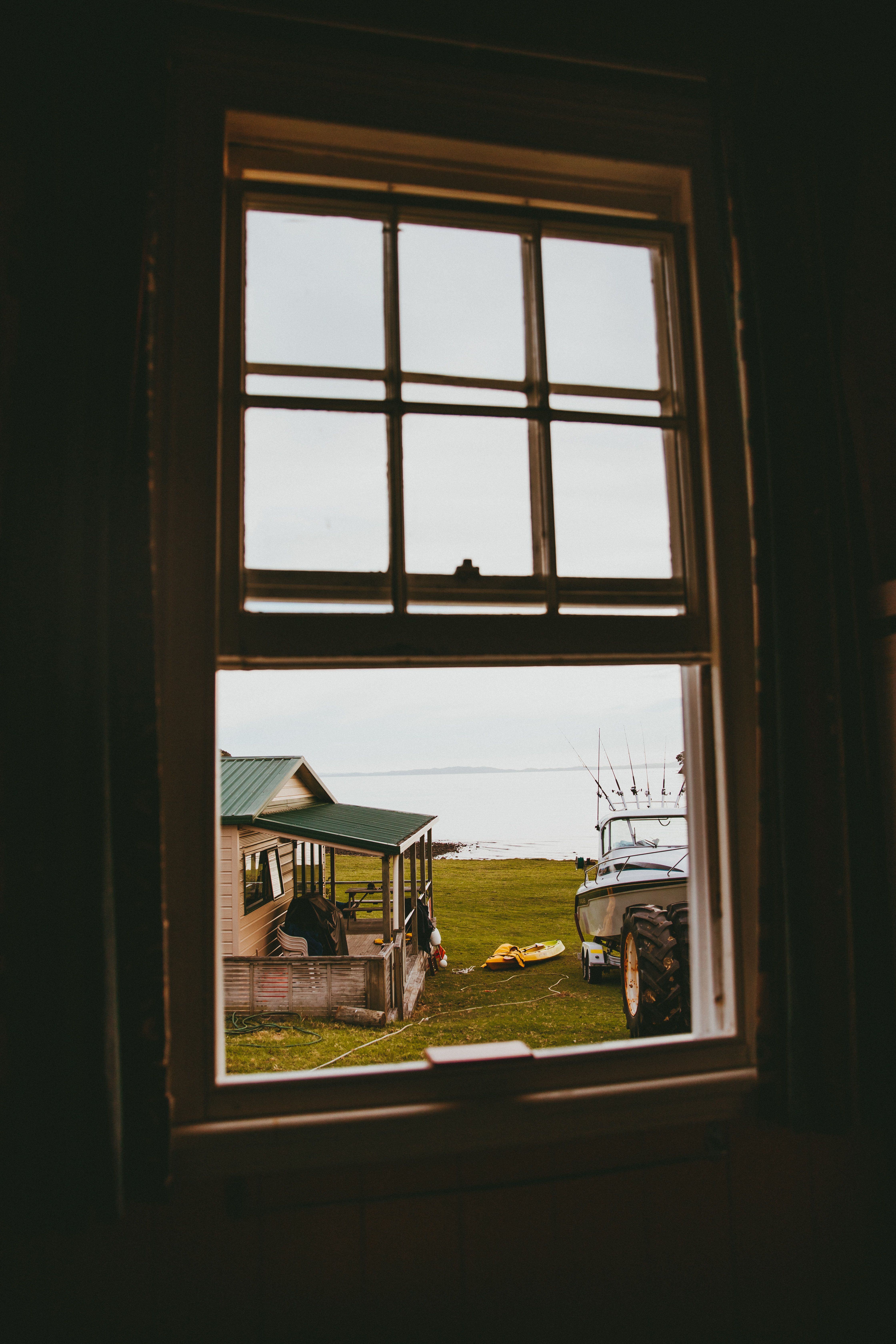 Village House on Sea Shore behind Window · Free Stock Photo