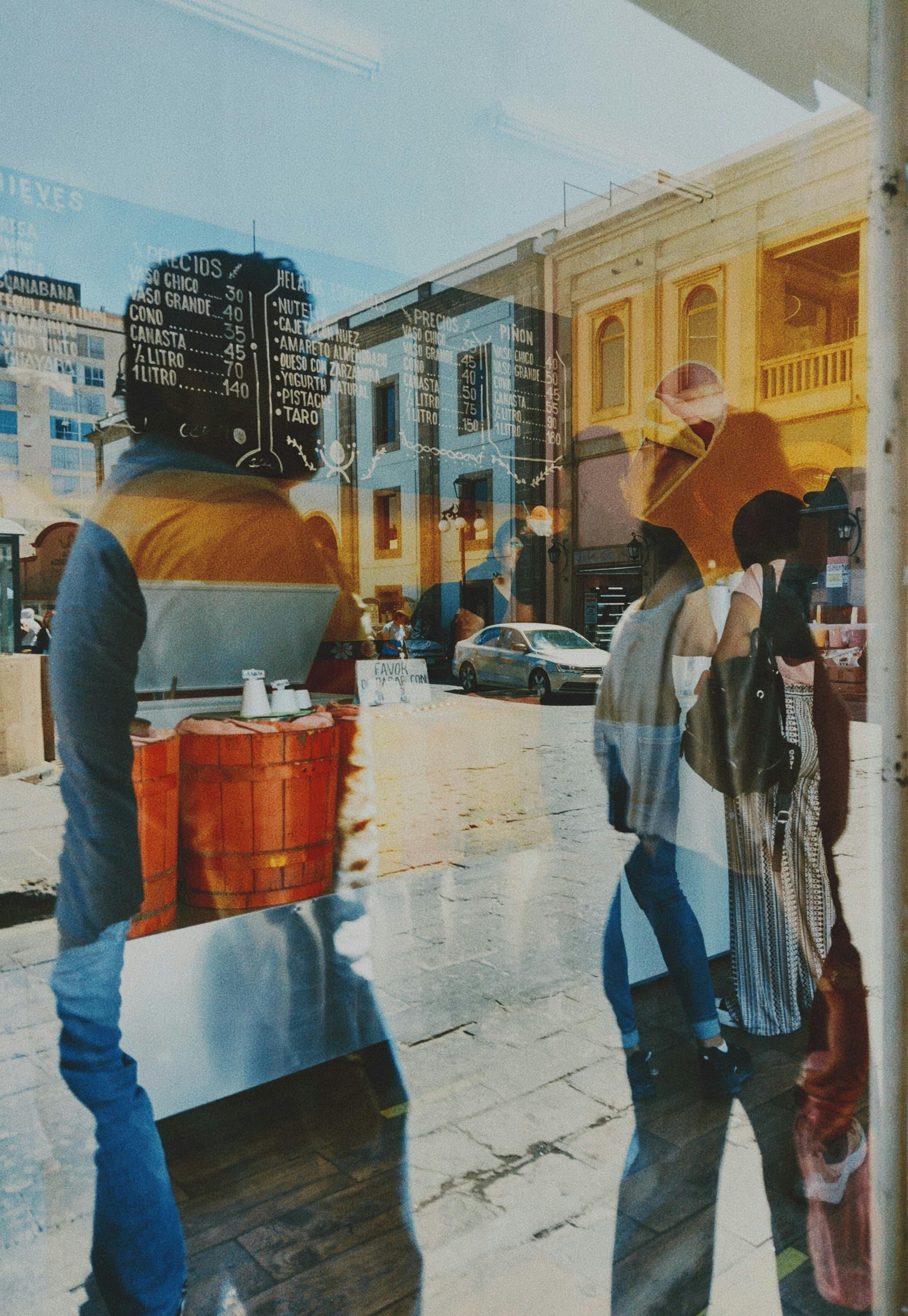 Walking Woman and Man Reflection in Cafe Window · Free Stock Photo