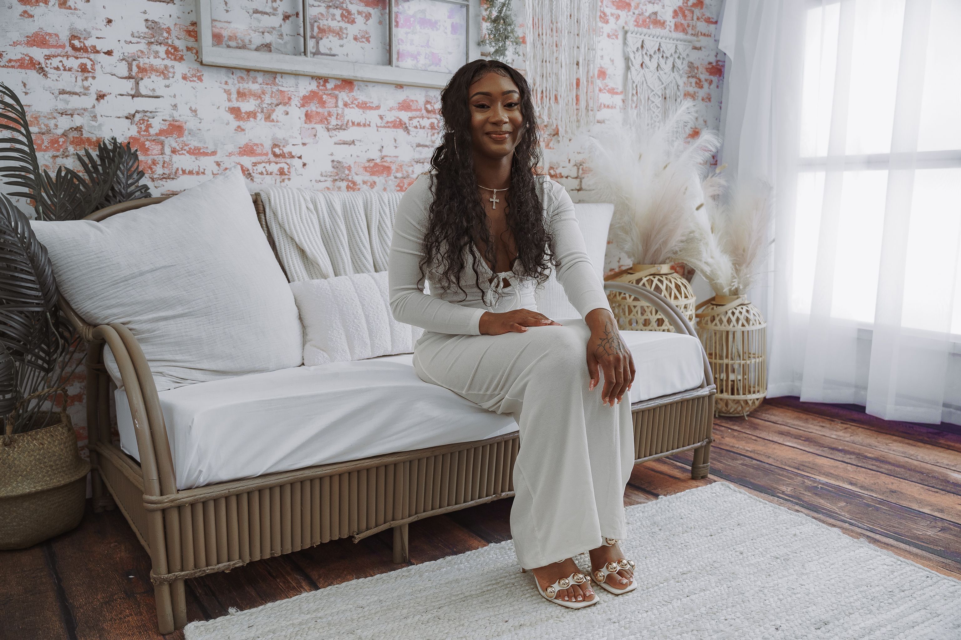 Portrait of a Woman Sitting on a Couch · Free Stock Photo