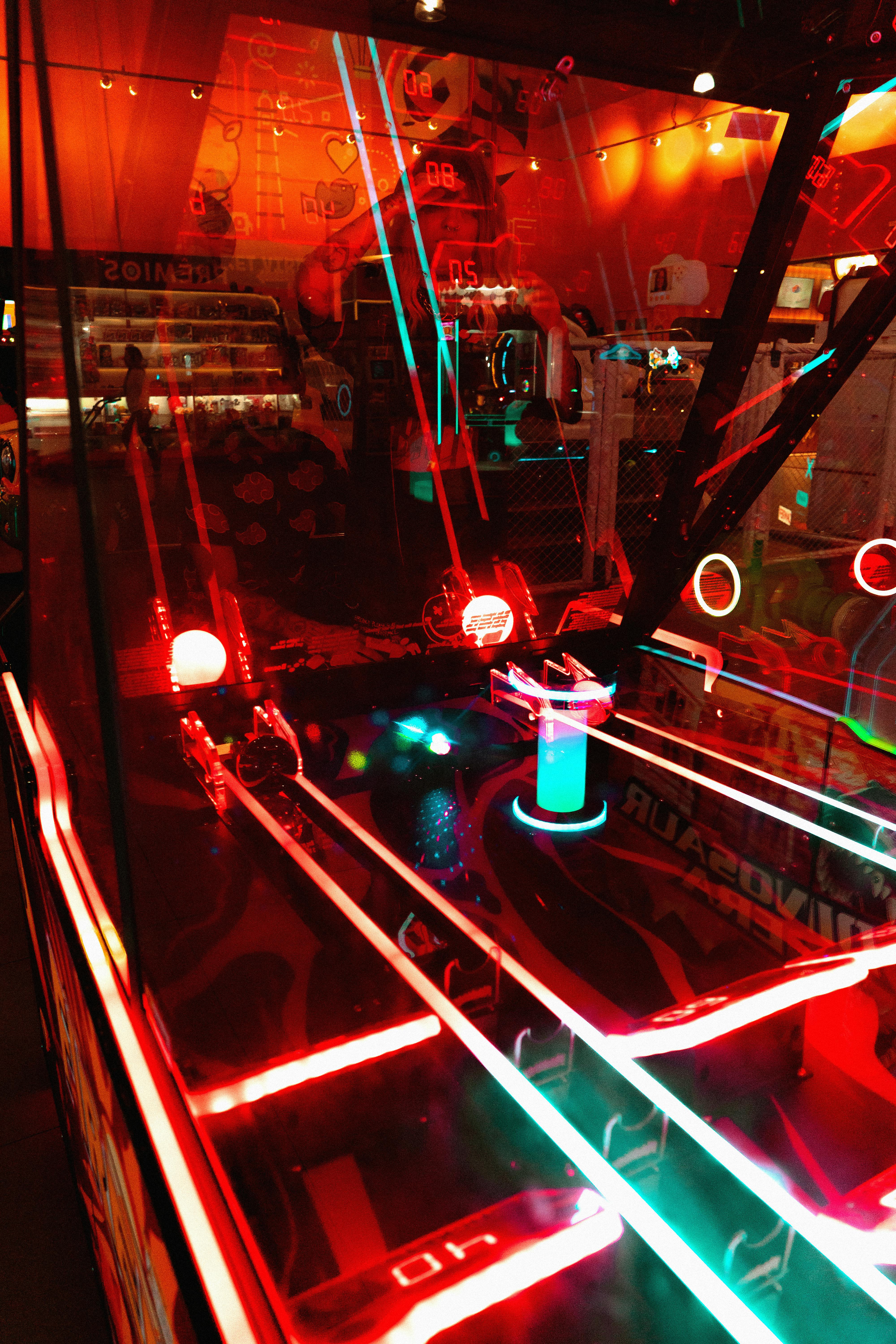 A neon lit arcade game with a red and green light · Free Stock Photo