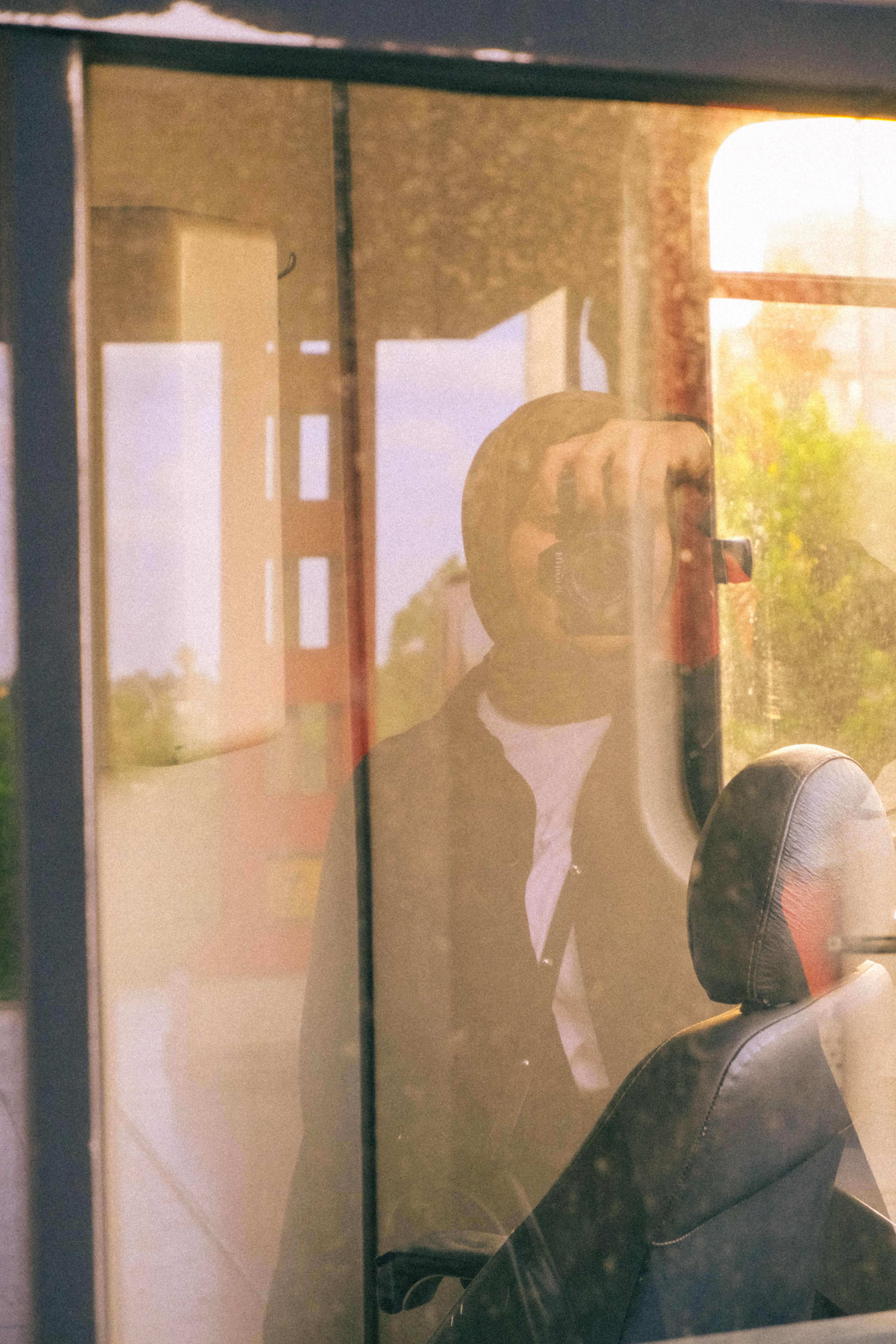 Reflection of a Person Taking a Photo Through a Glass · Free Stock Photo
