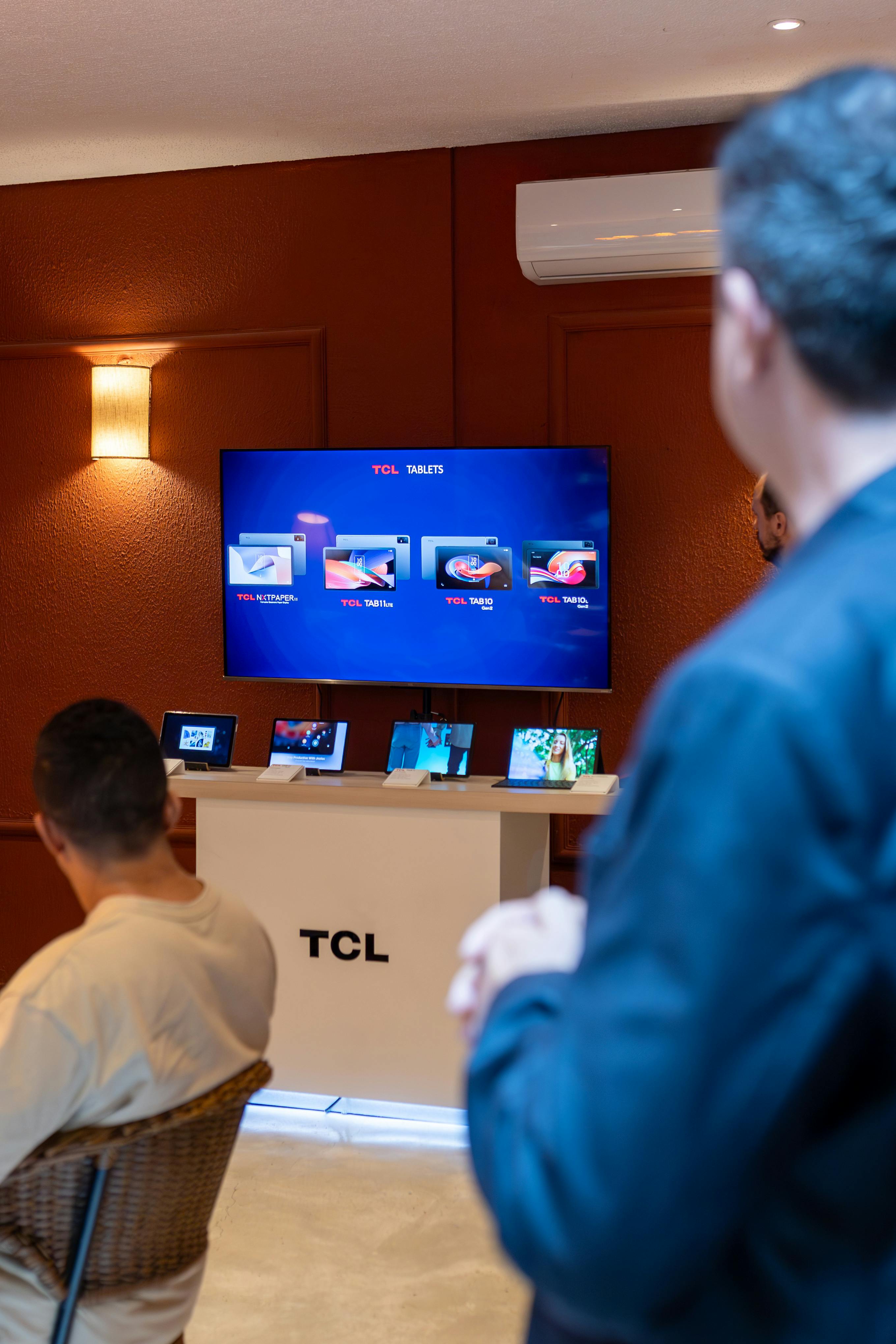 People in a Showroom with Electronic Devices · Free Stock Photo