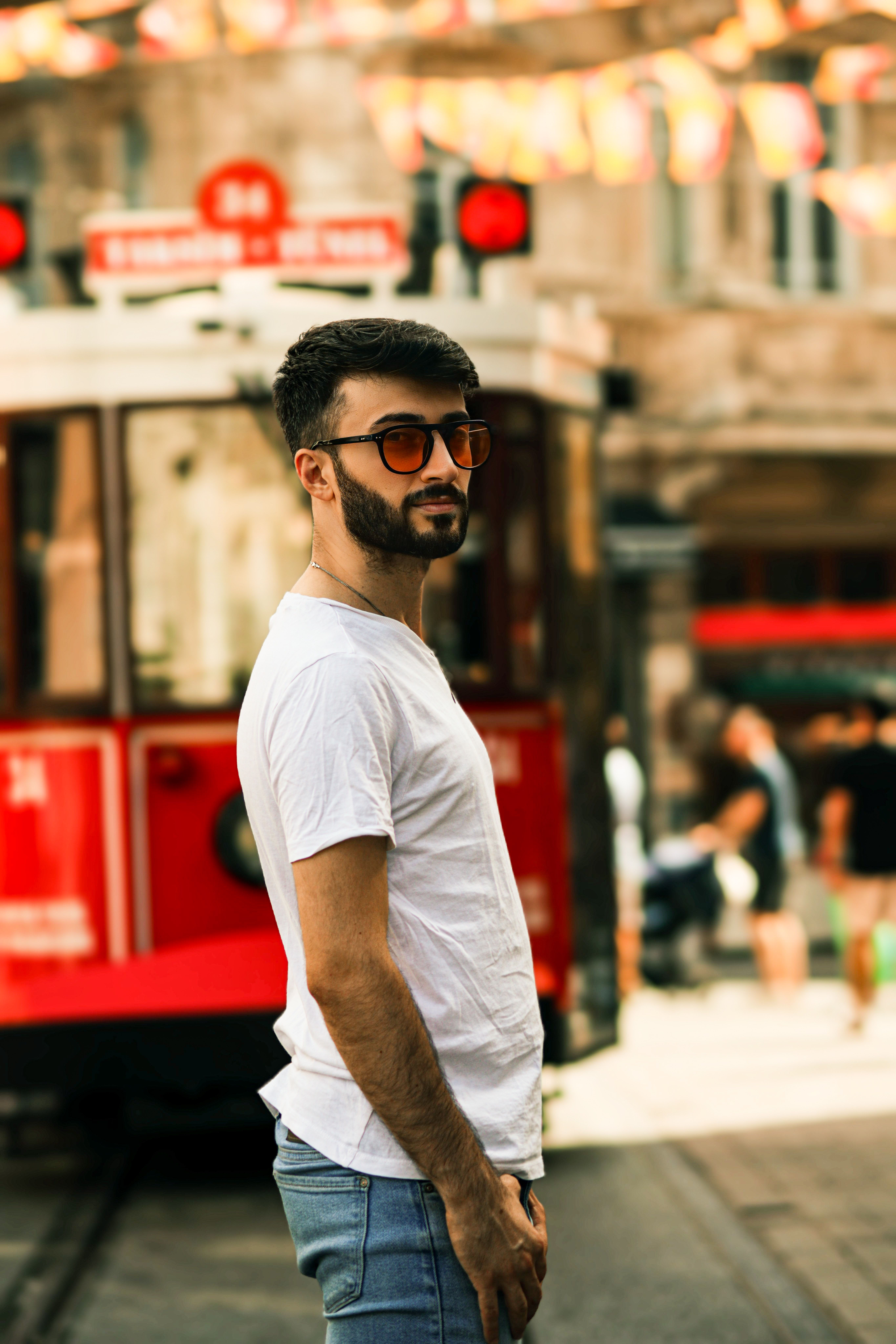 Tourist Posing in Front of a Vintage Tram · Free Stock Photo