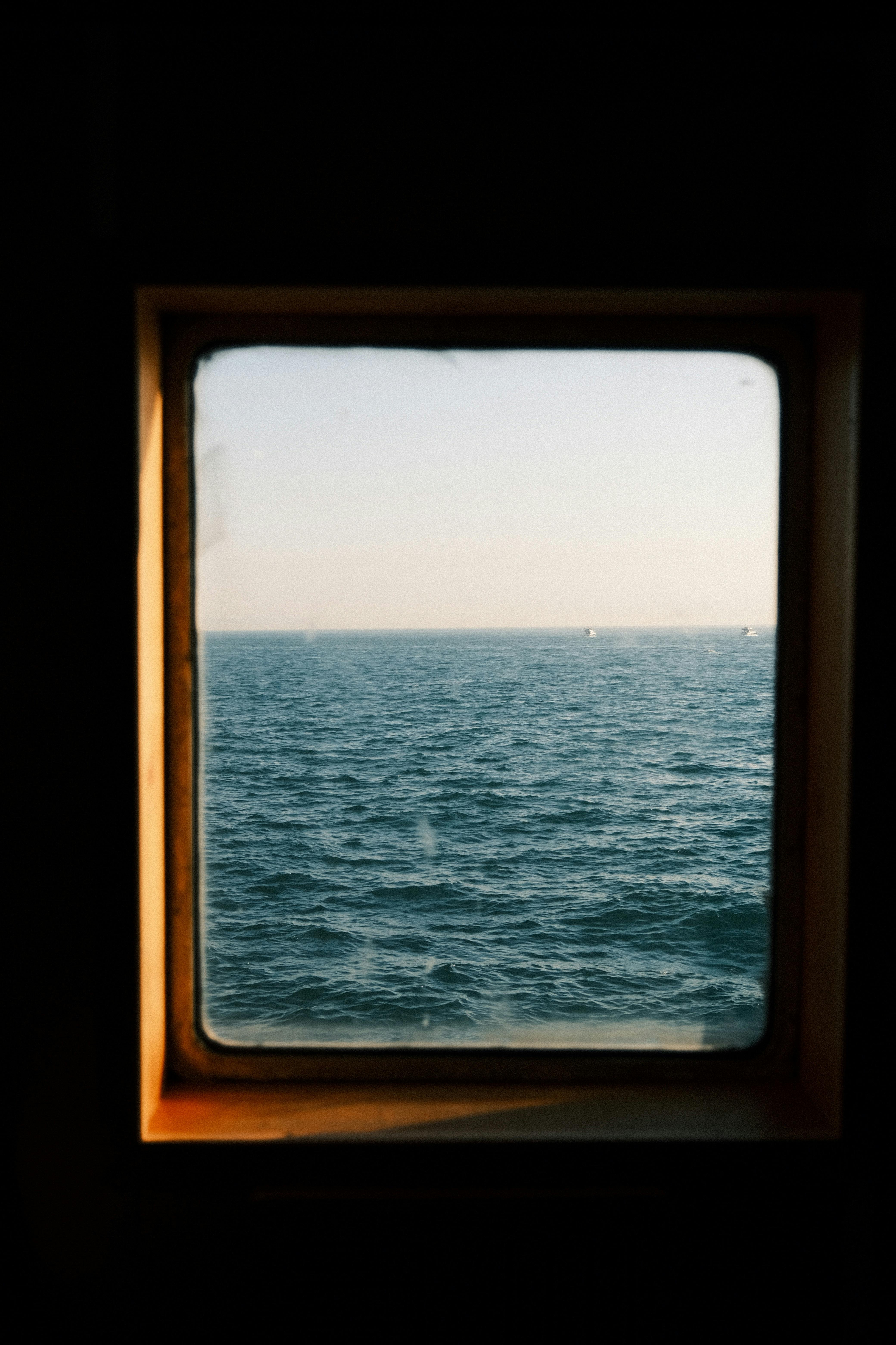 Sea behind Window of Sailing Vessel · Free Stock Photo