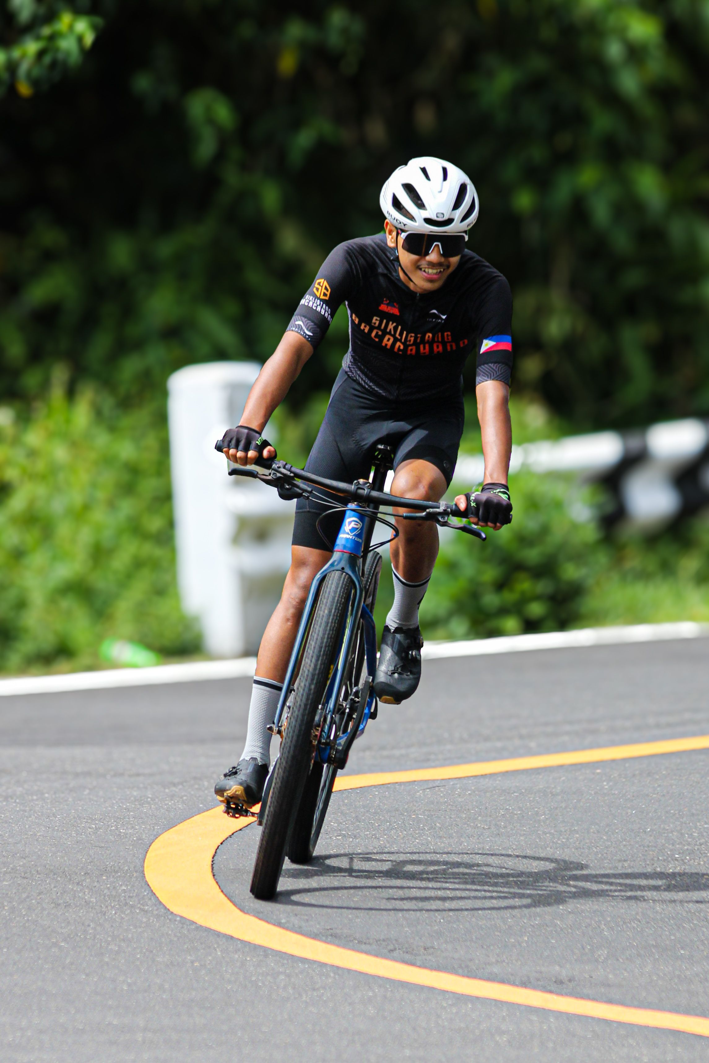 Smiling Cyclist in Training on Road · Free Stock Photo