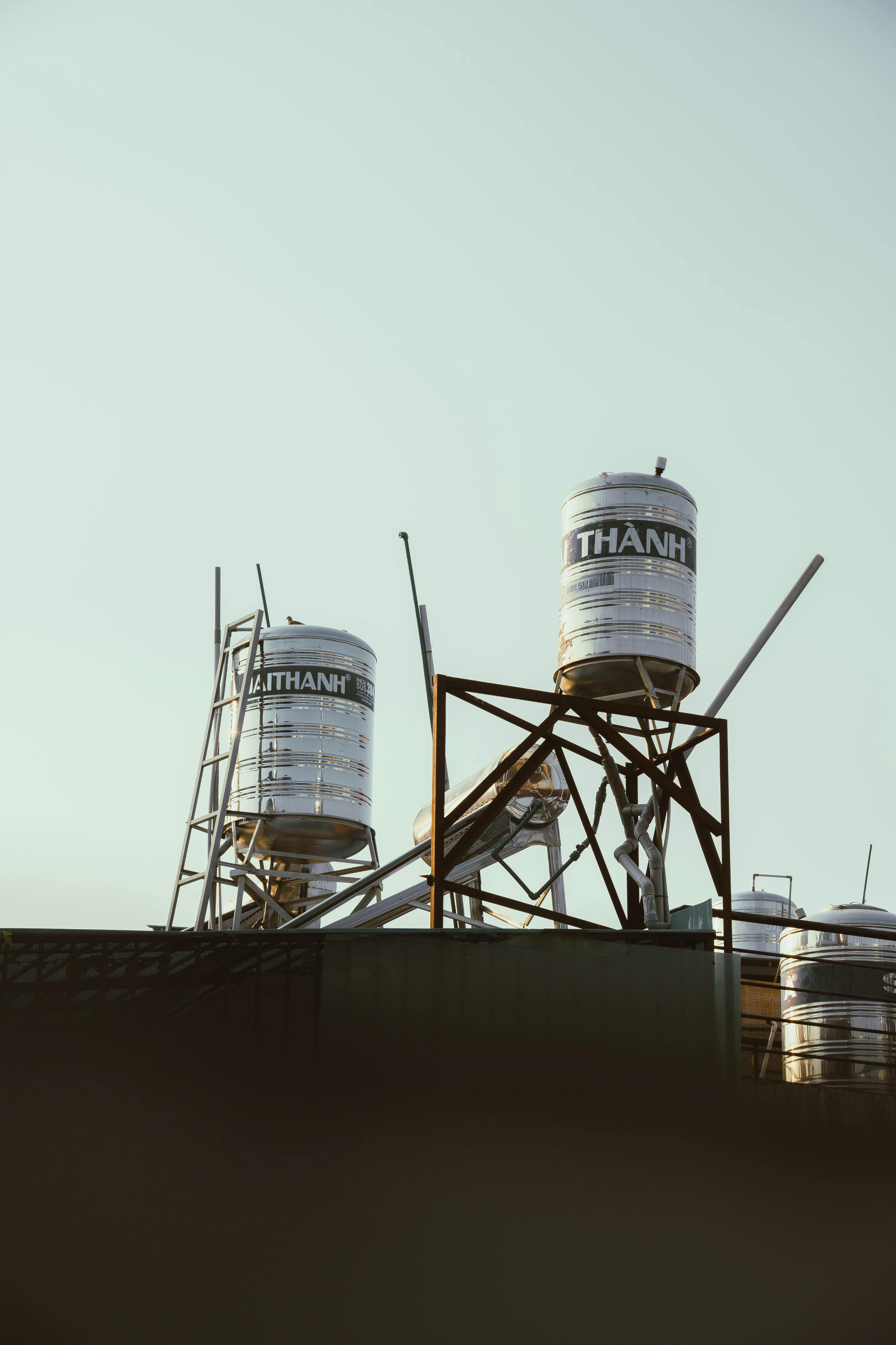 Water Tanks on a Rooftop · Free Stock Photo