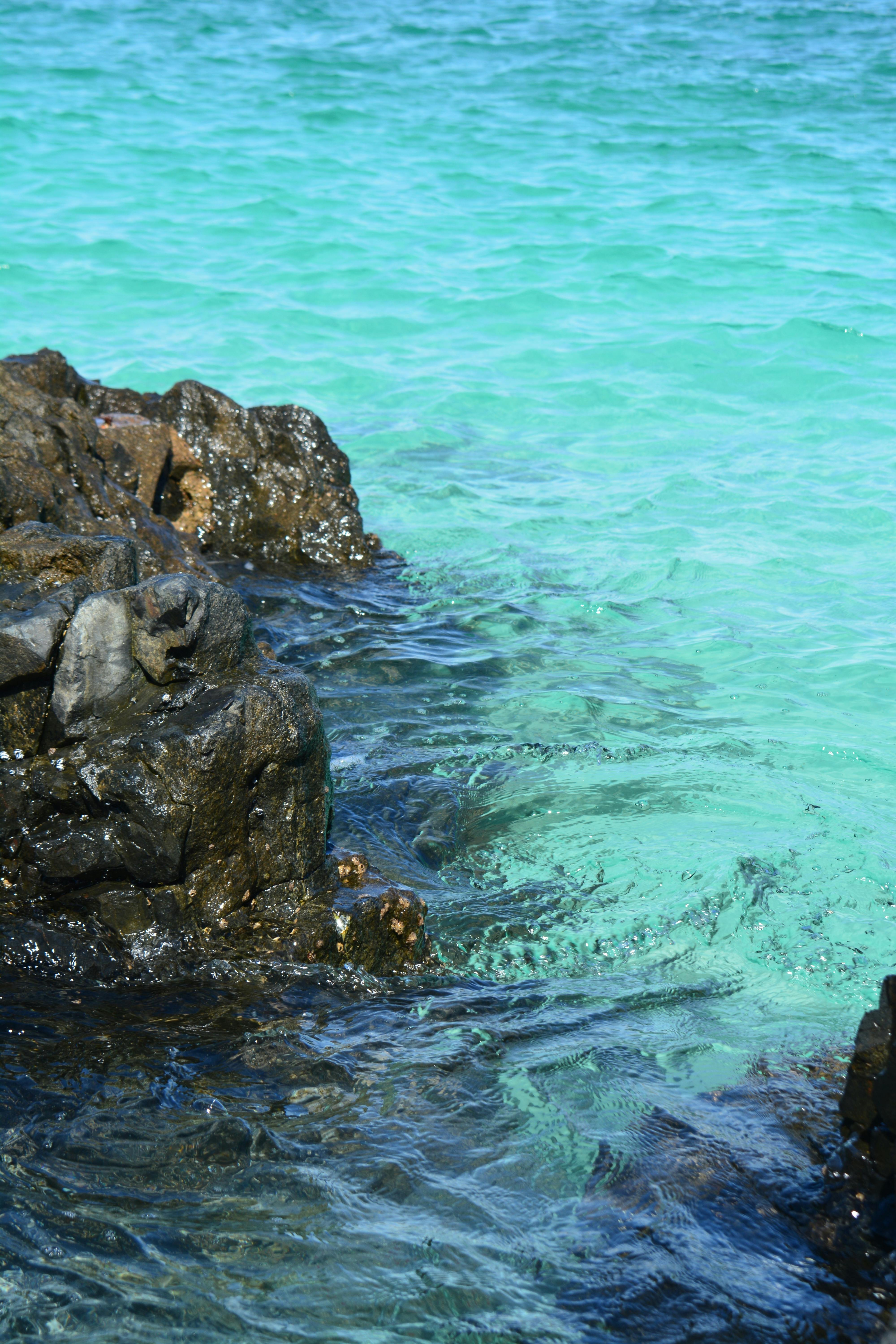 Landscape Photography of Rocks Surrounded by Body of Water · Free Stock ...
