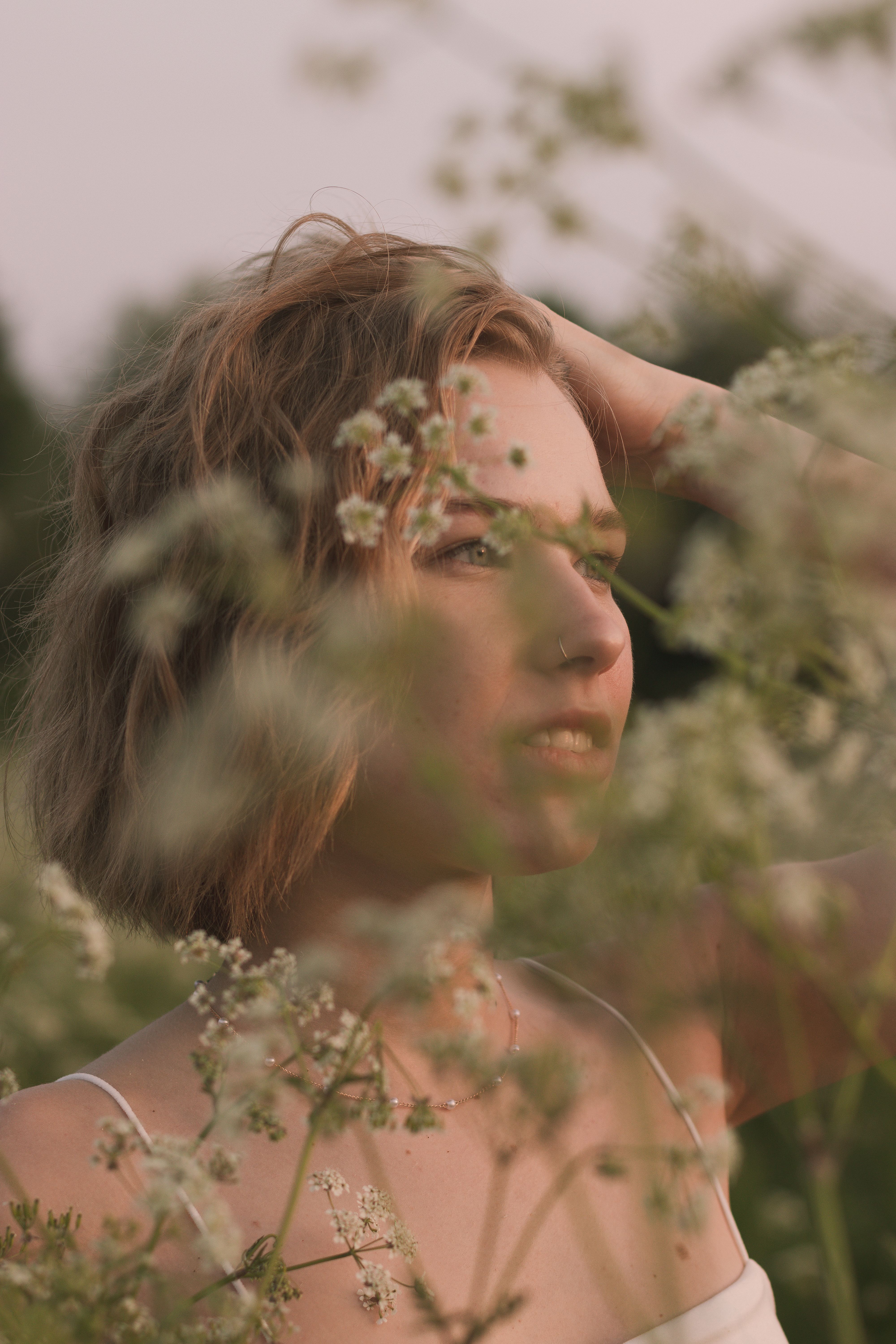 Portrait of Woman behind Flowers · Free Stock Photo