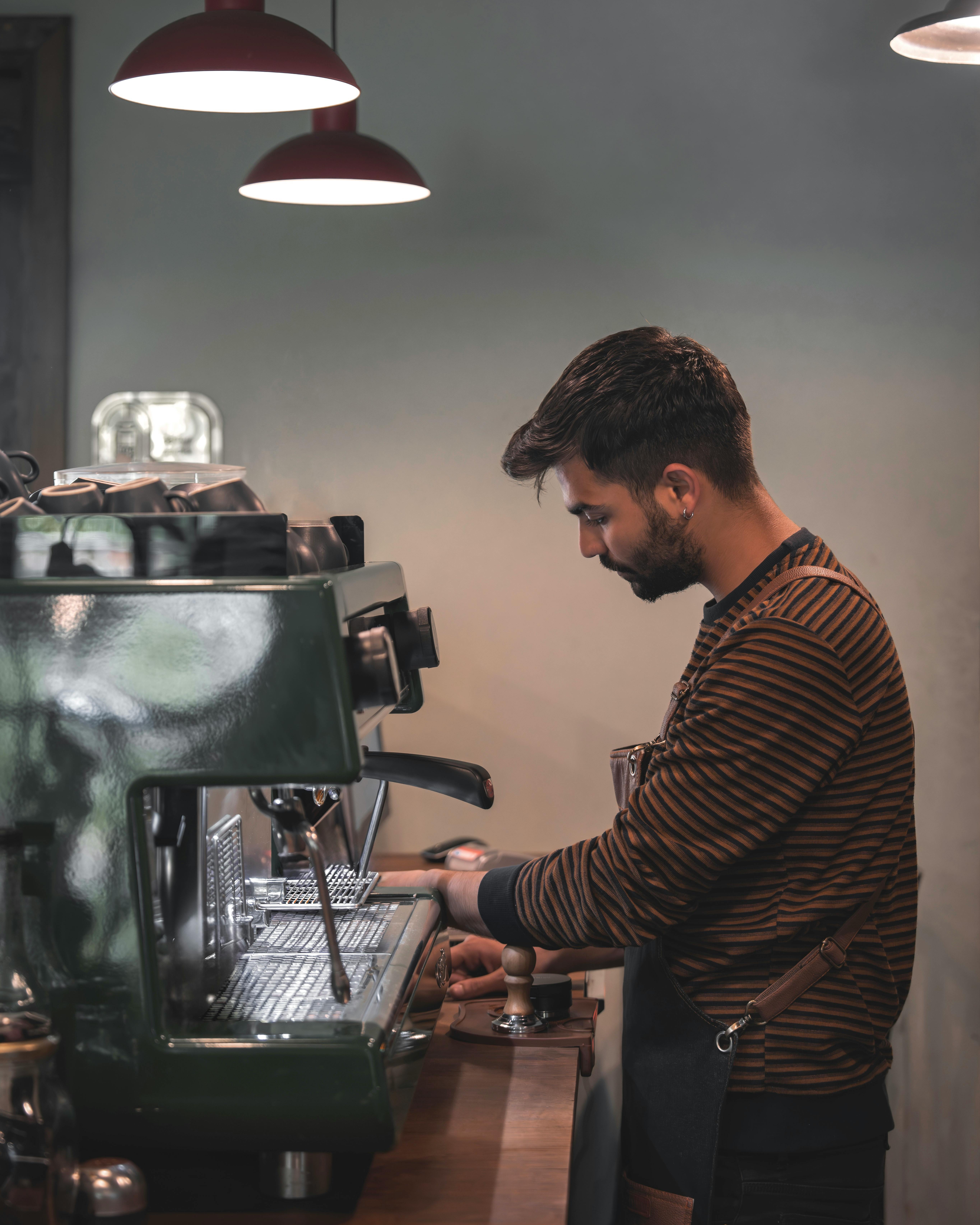 A man is making coffee in a cafe · Free Stock Photo