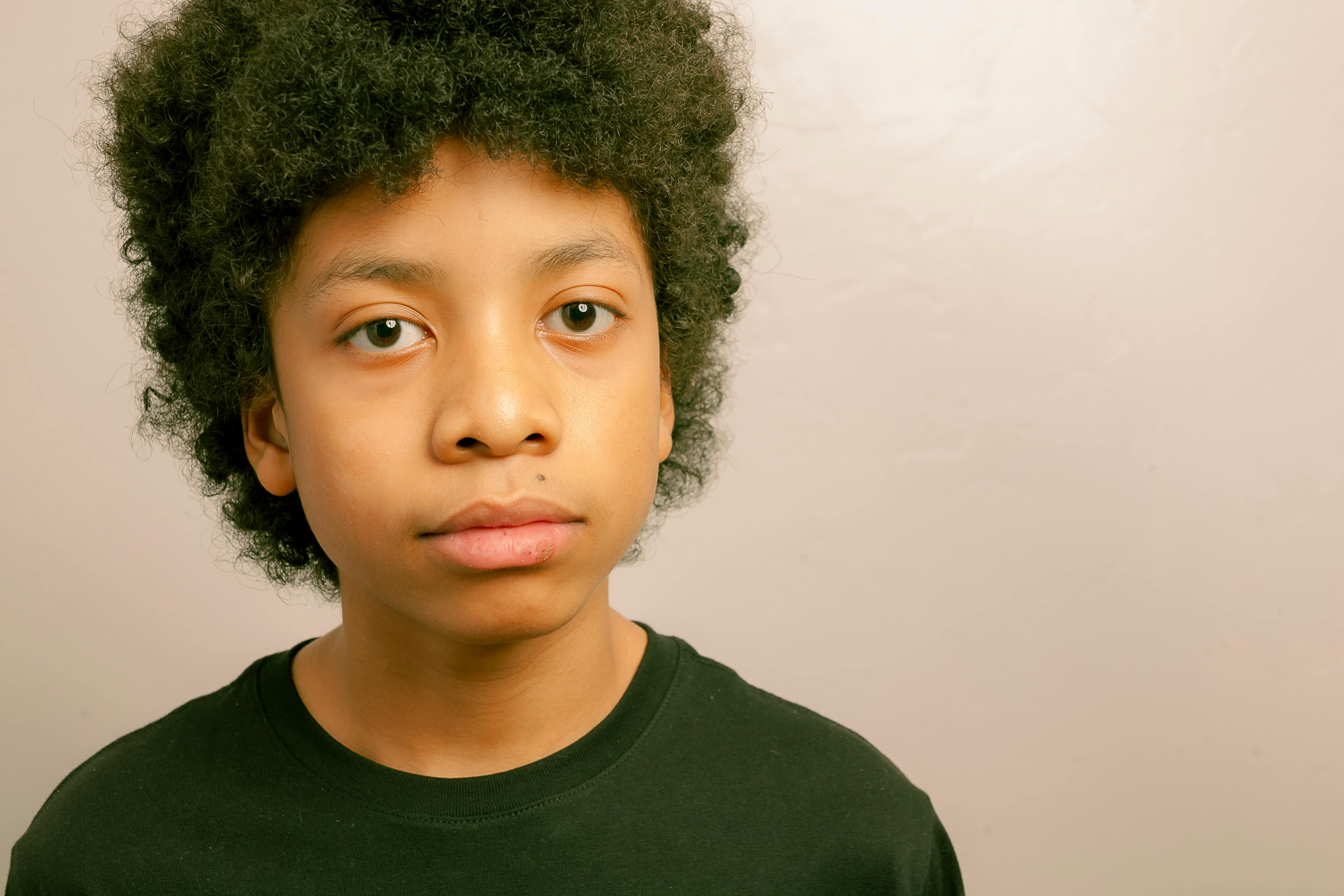 A young boy with an afro hair style · Free Stock Photo