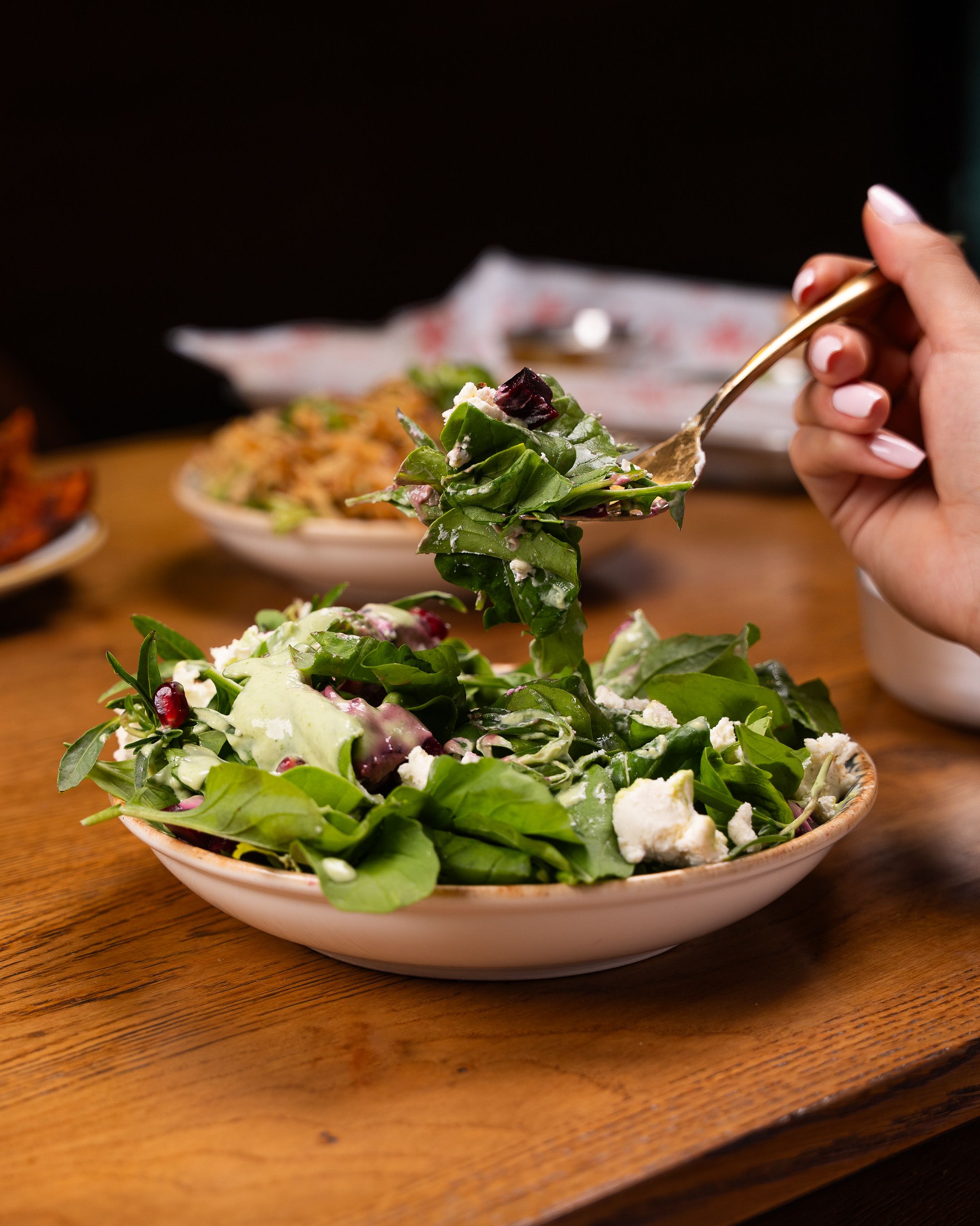 Hand of a Woman Eating Salad with Cheese · Free Stock Photo