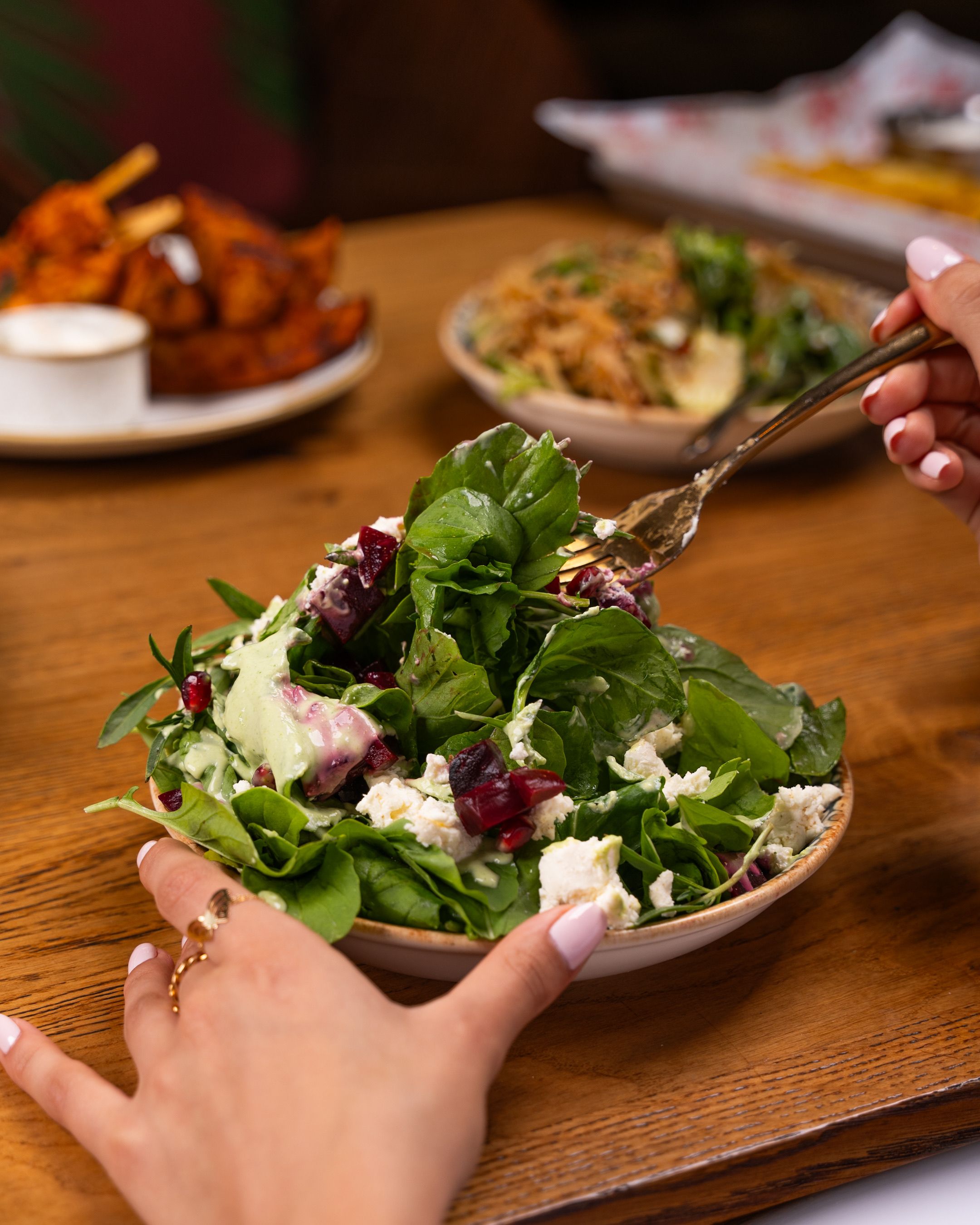 Hands of a Woman Eating Salad with Cheese · Free Stock Photo