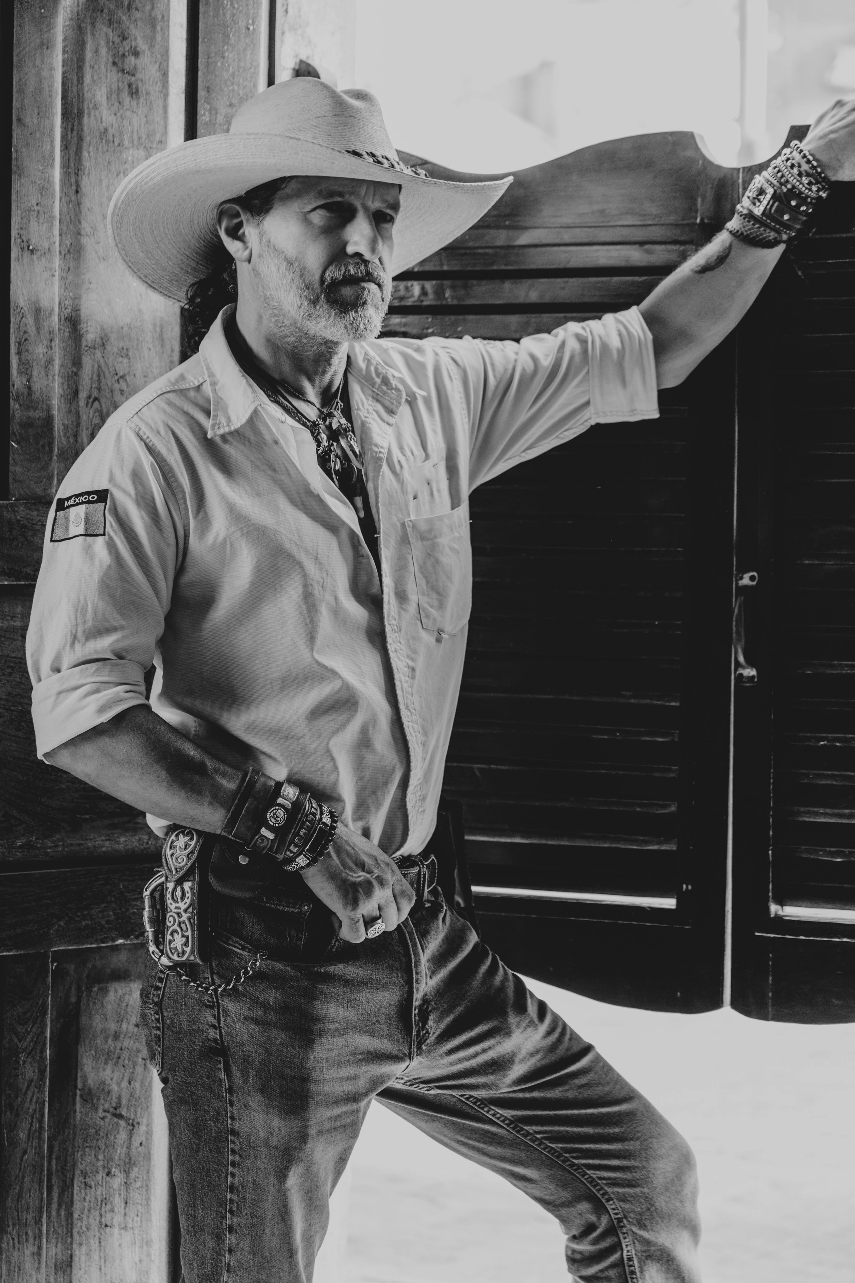 Cowboy Posing by Swinging Doors · Free Stock Photo