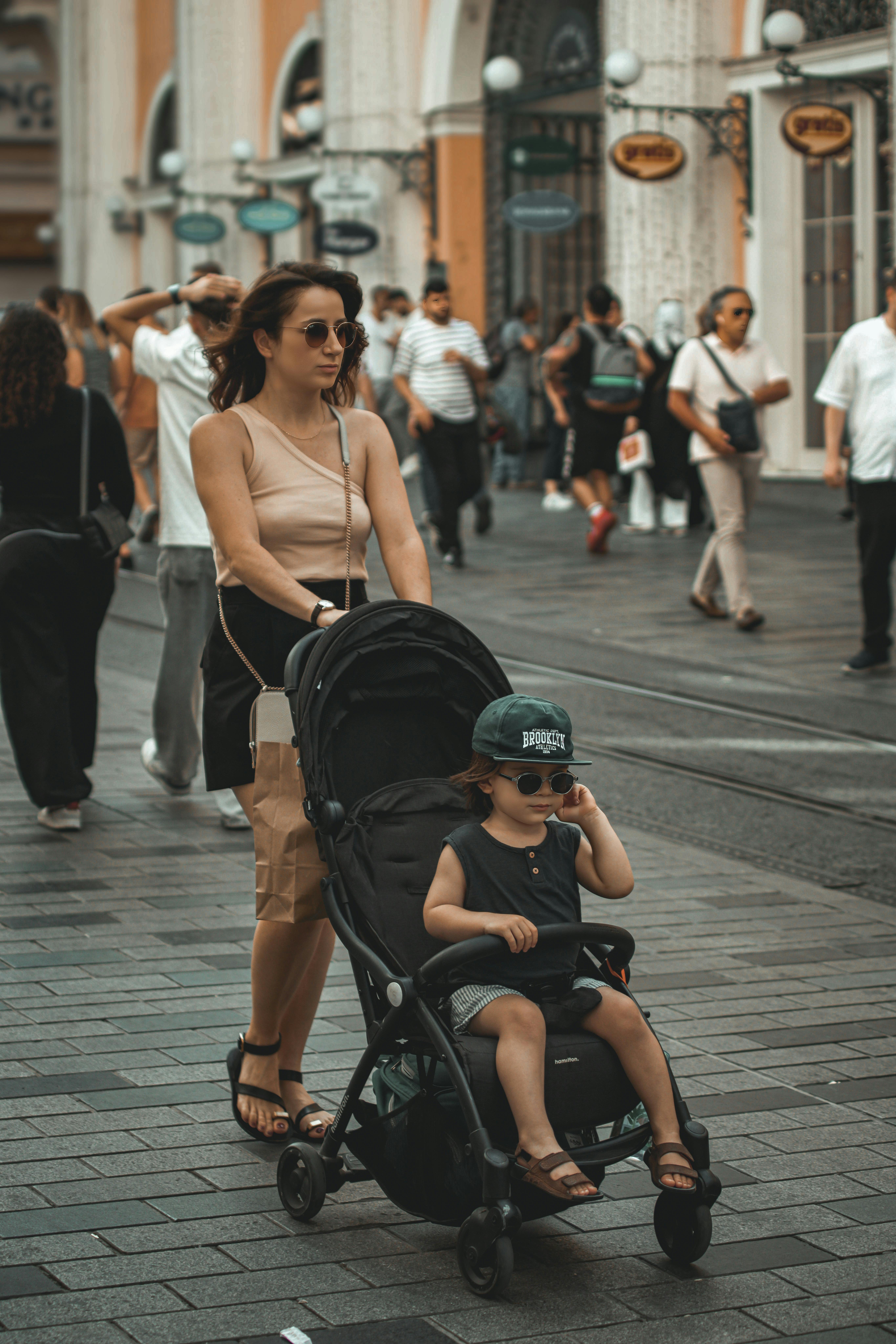 Woman with Baby in a Cart · Free Stock Photo