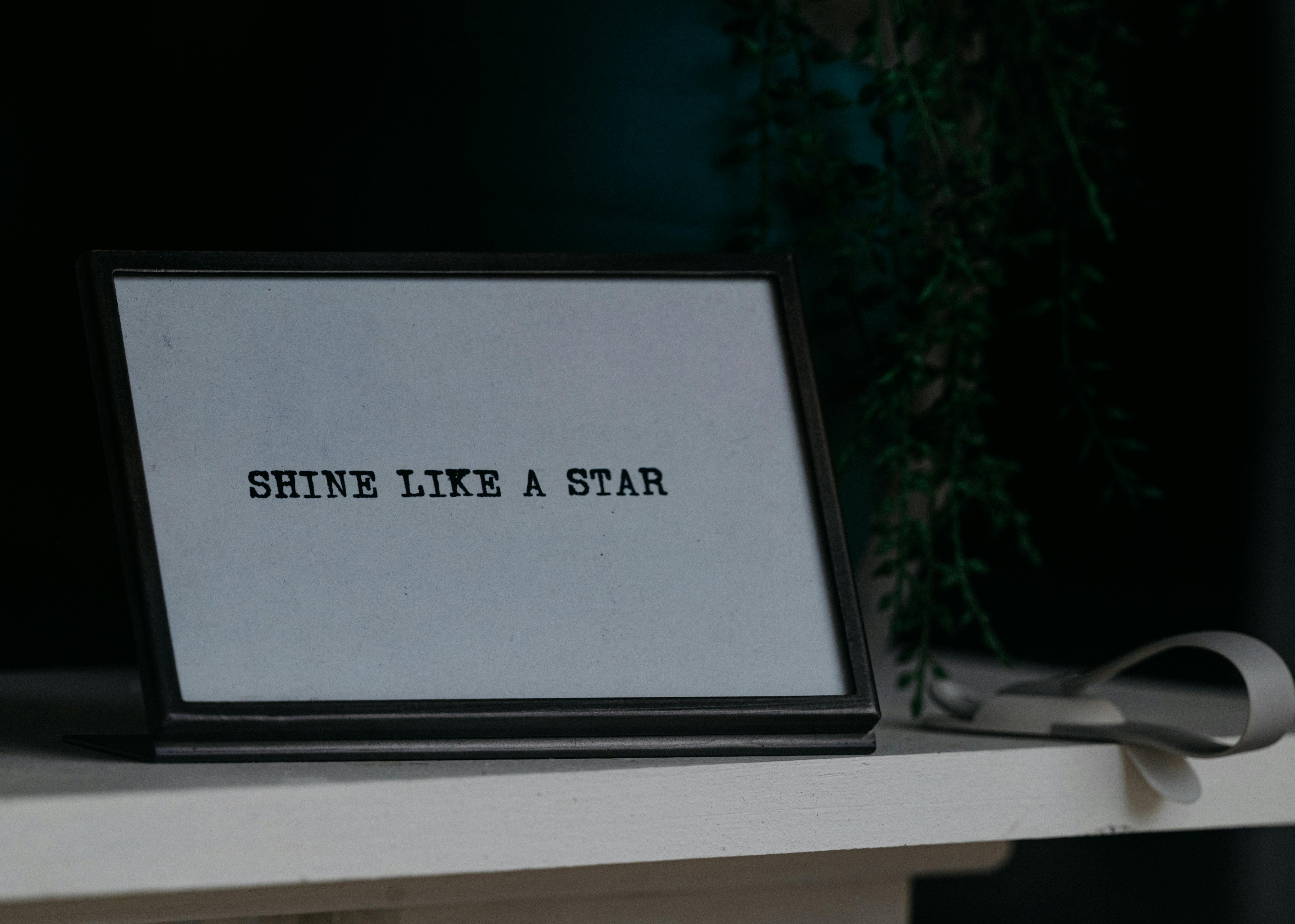 Slogan in Black Frame on Desk · Free Stock Photo