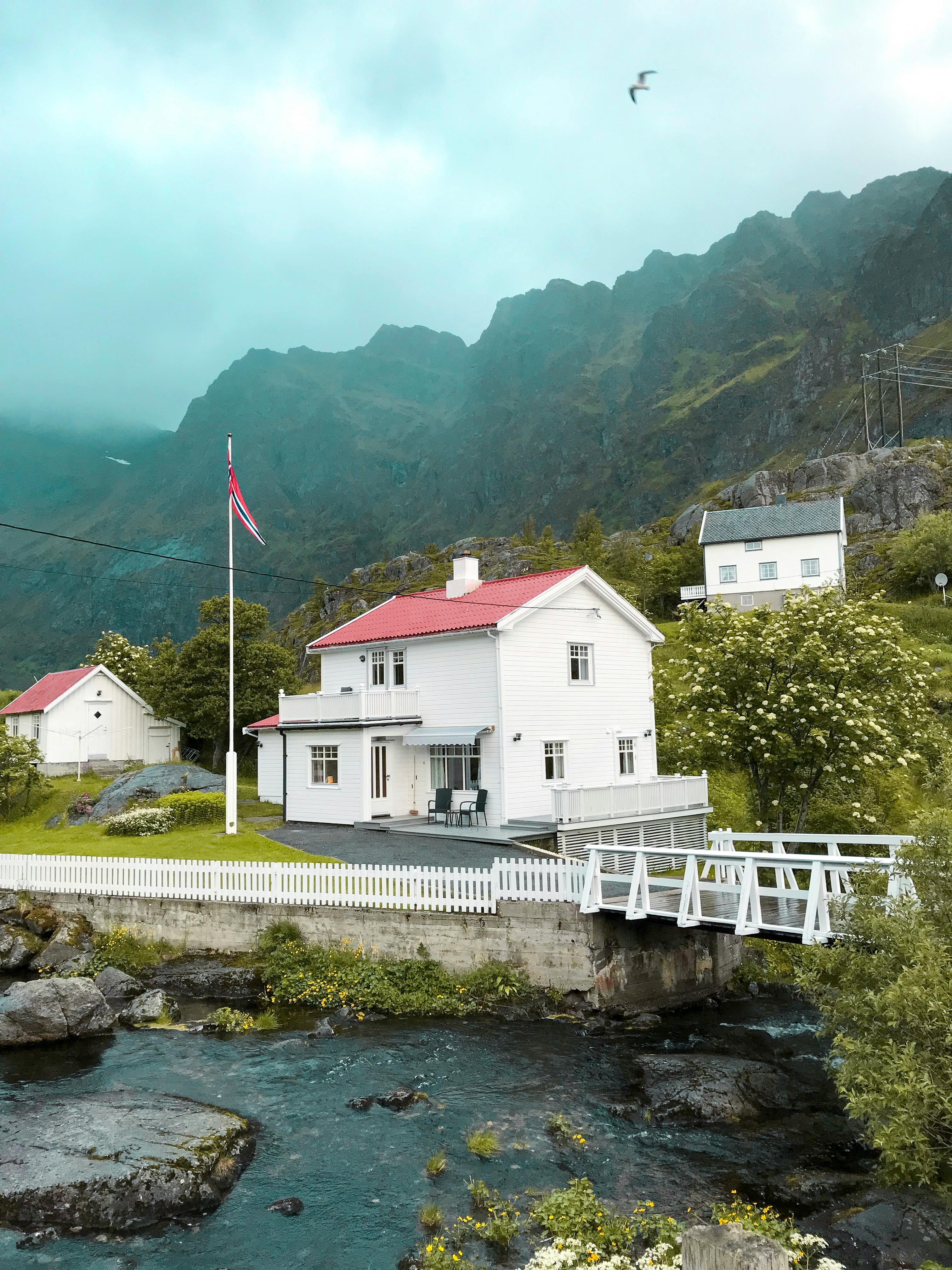 White Concrete Building Near River · Free Stock Photo