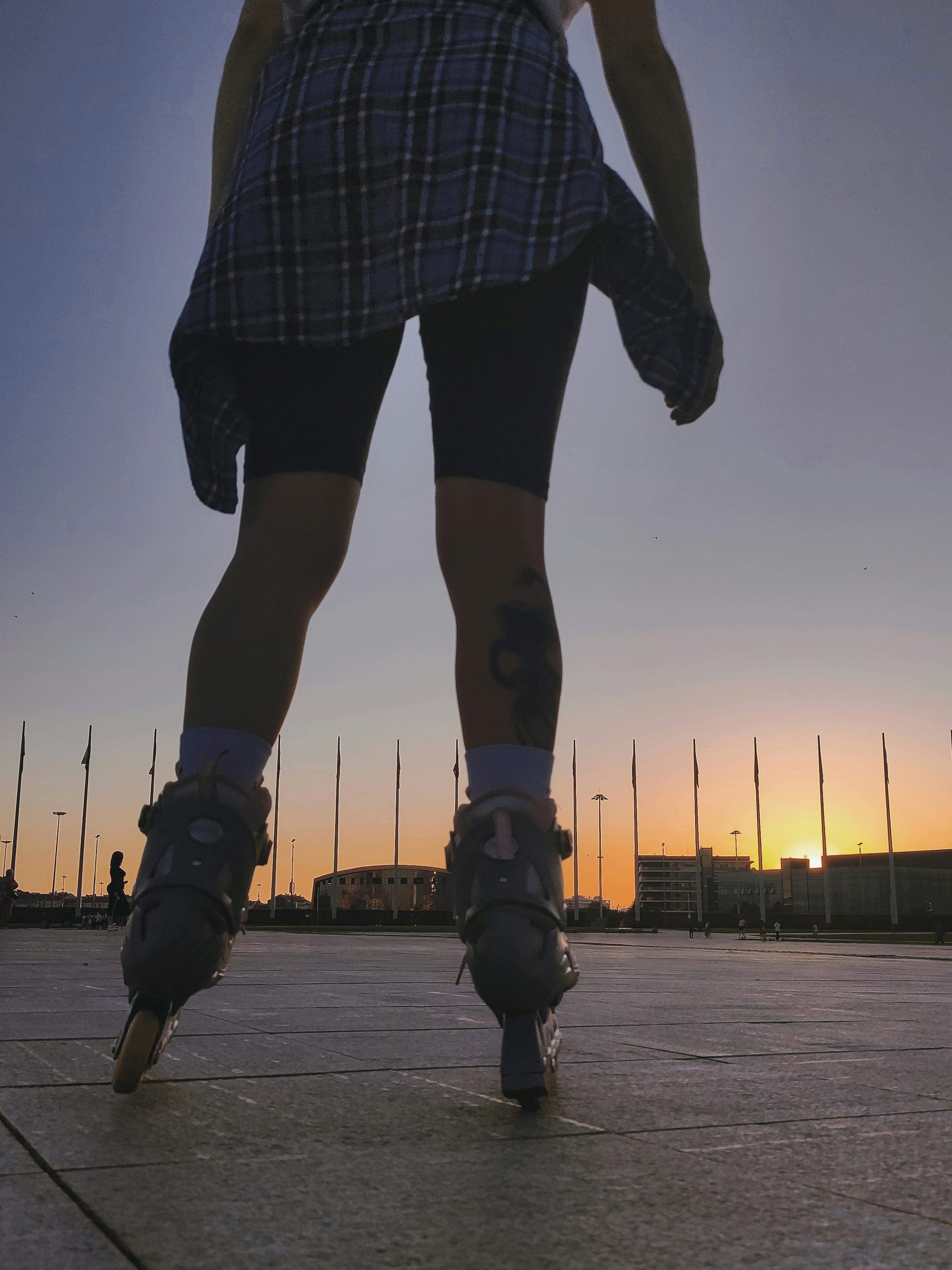 Back View of Person Rollerskating at Sunset · Free Stock Photo