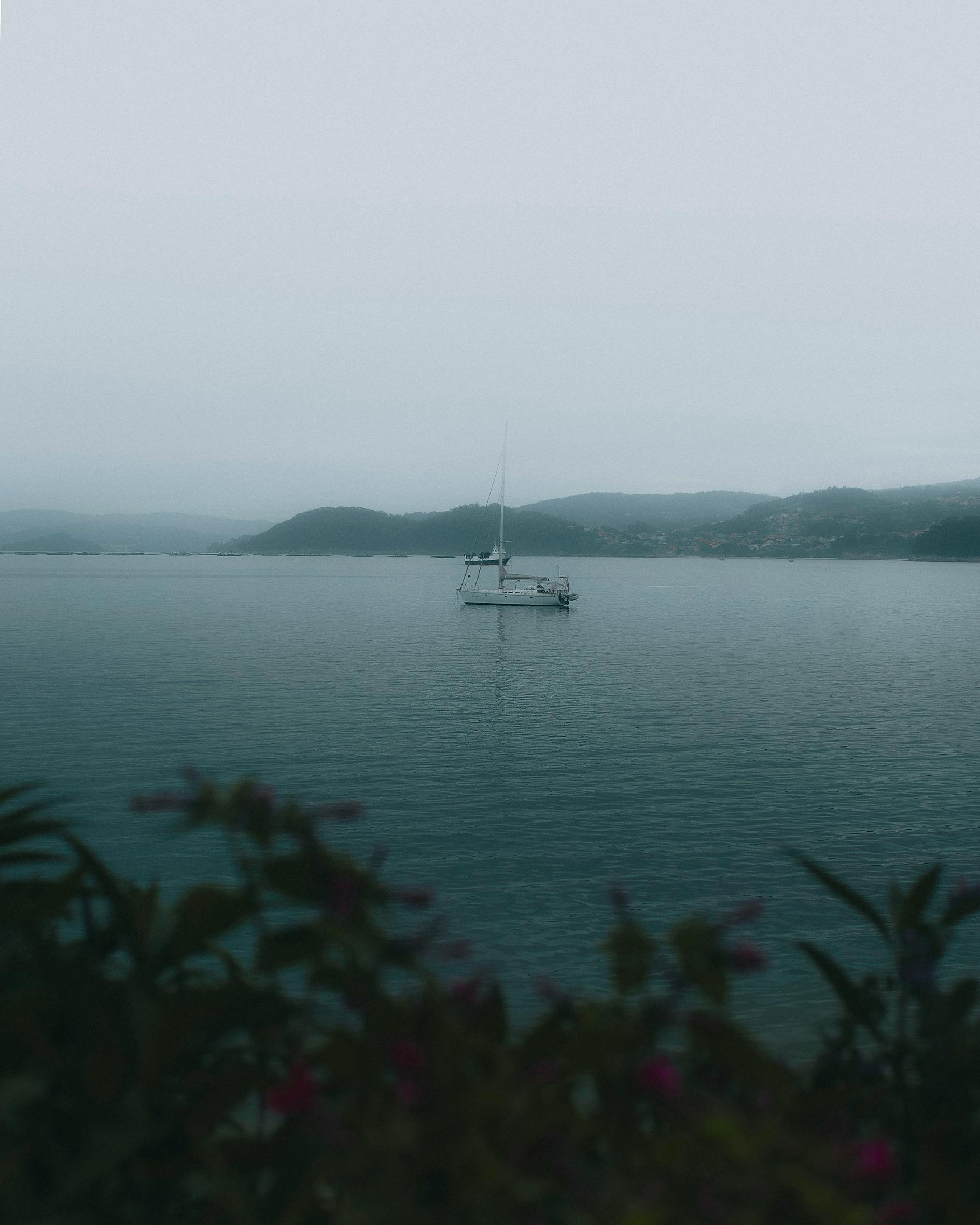 Sailboat in Bay on Sea Coast under Fog · Free Stock Photo