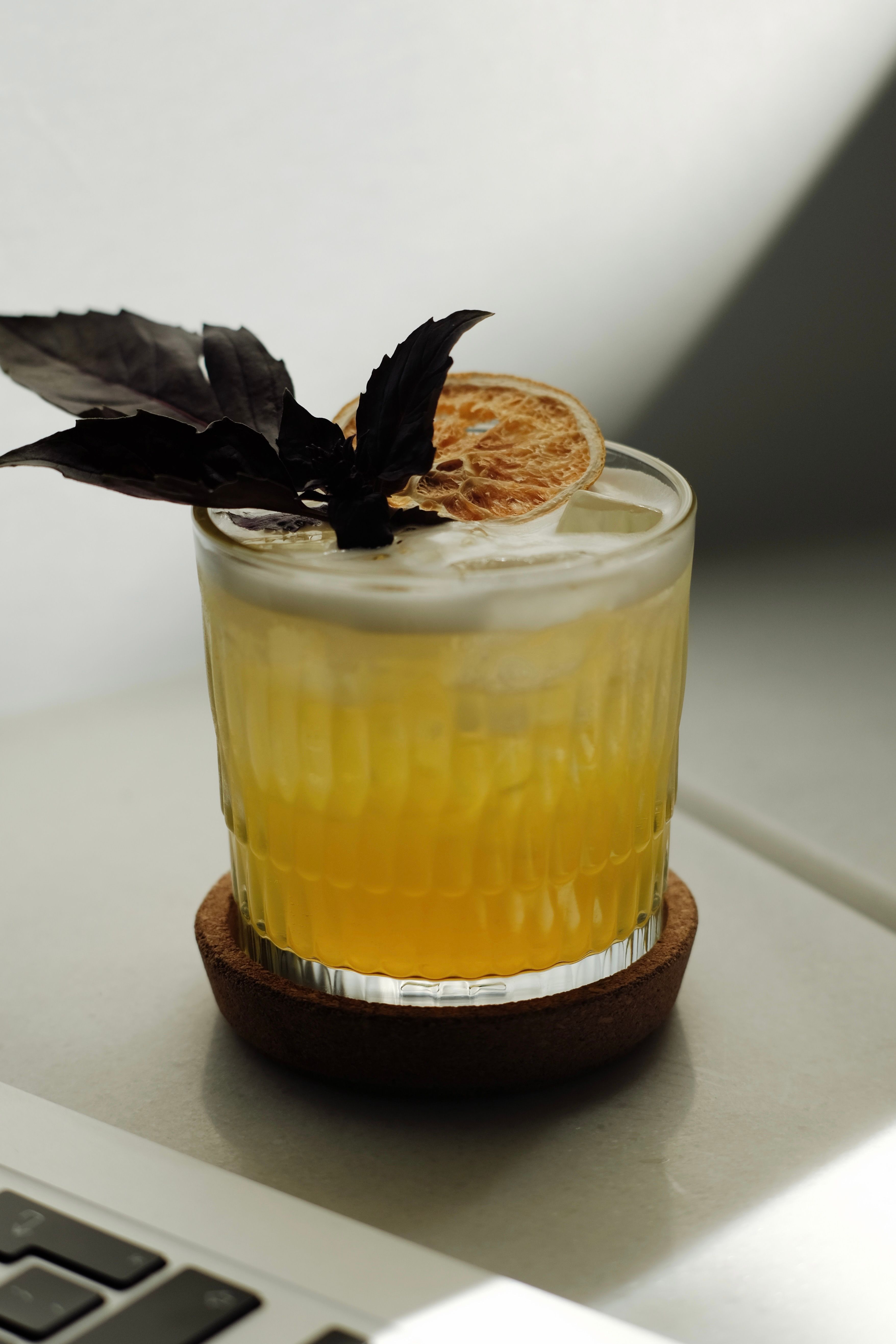 Close-up of a Cocktail Standing next to a Laptop · Free Stock Photo
