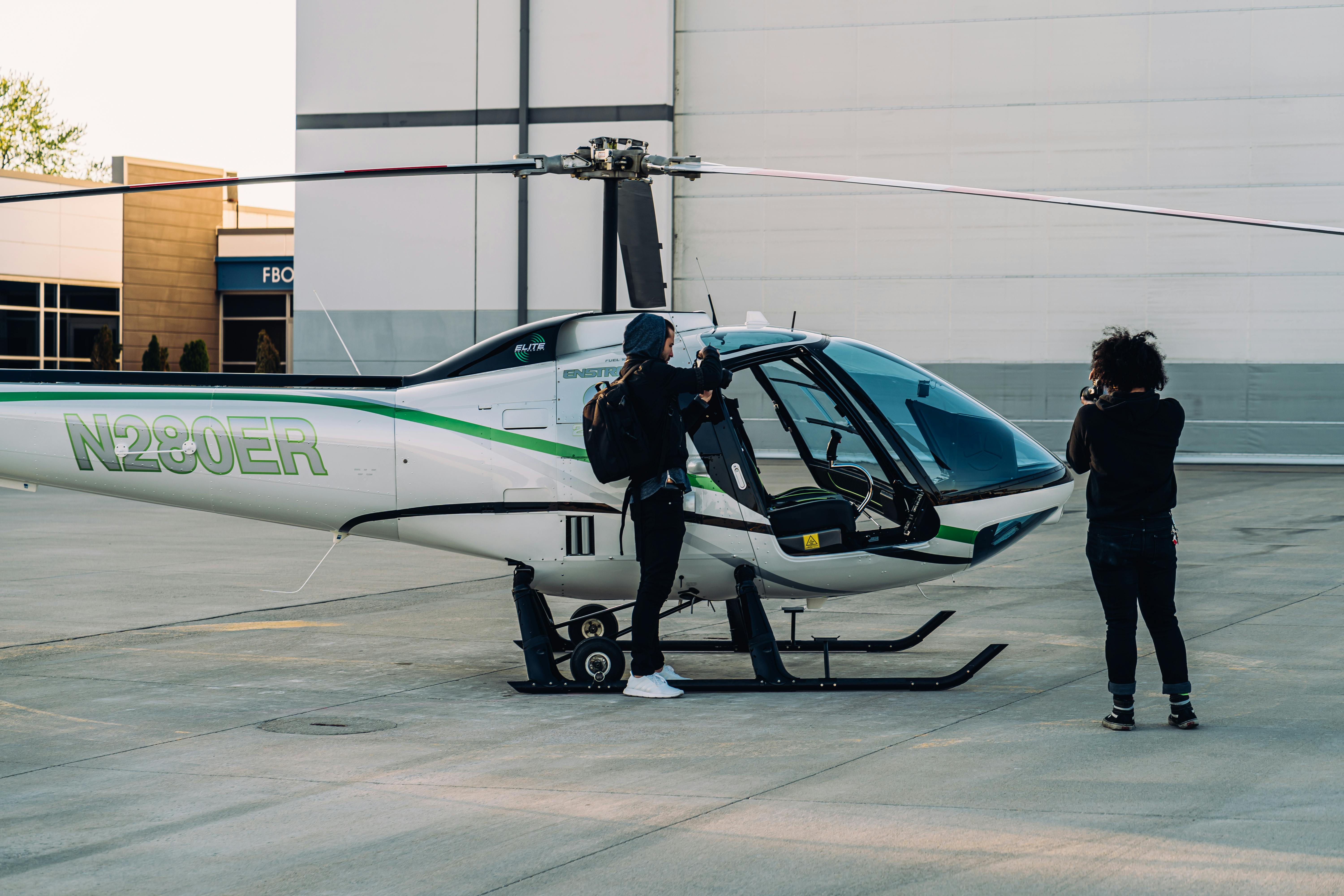 Two Person Near a Helicopter · Free Stock Photo