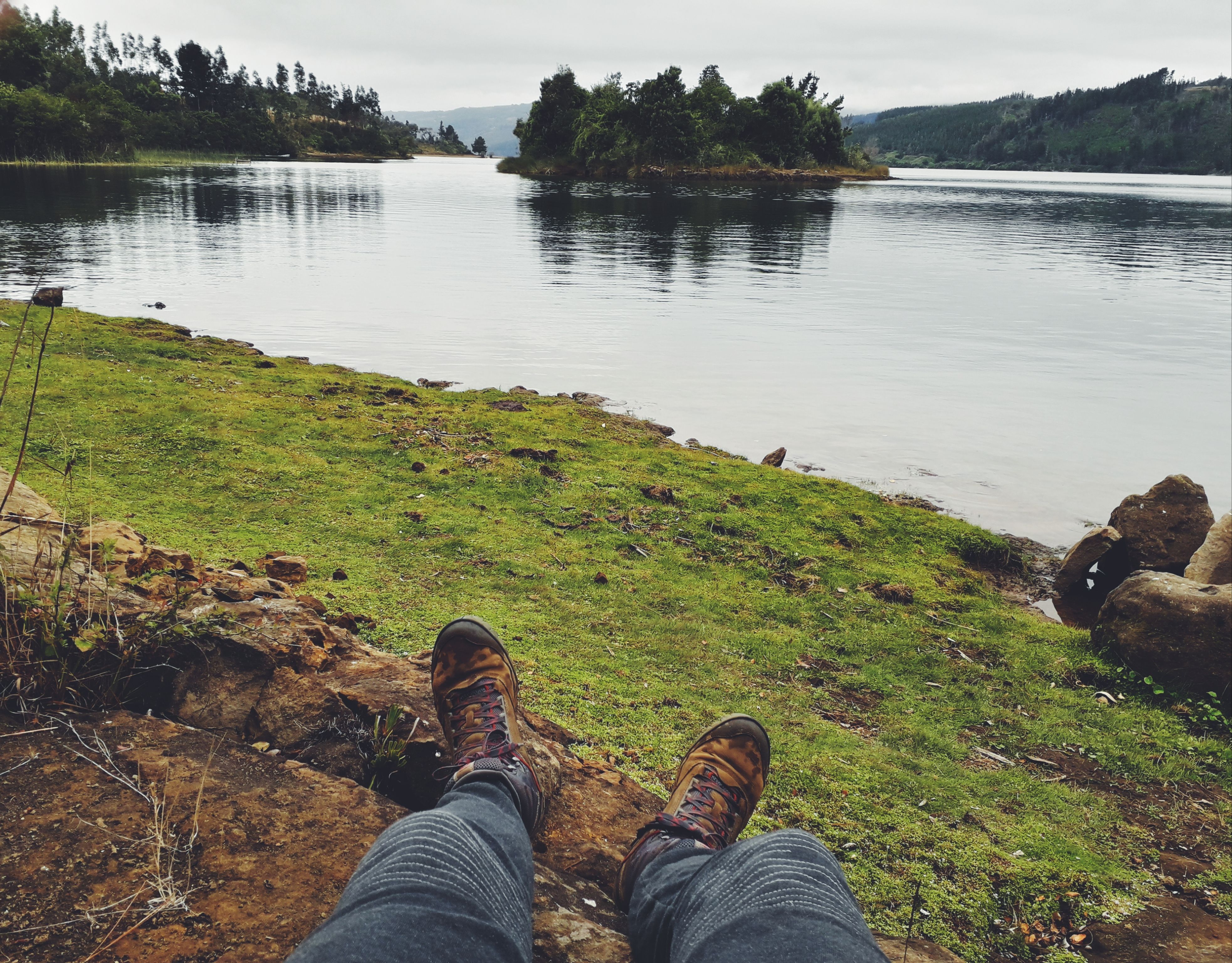 Photo of Person Sitting on Ground Near River · Free Stock Photo