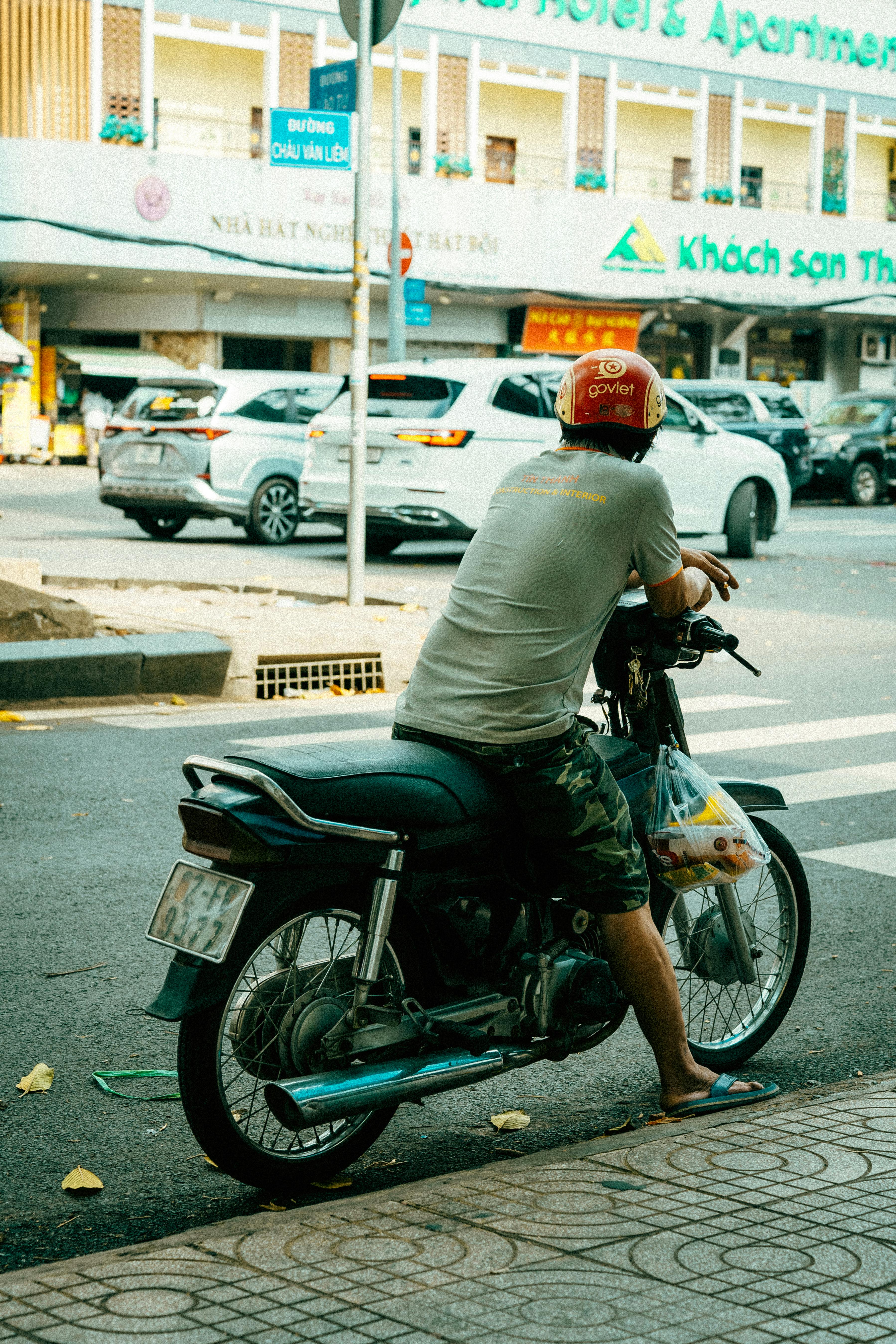 Back View of Man Sitting on Moped on Side of Street · Free Stock Photo