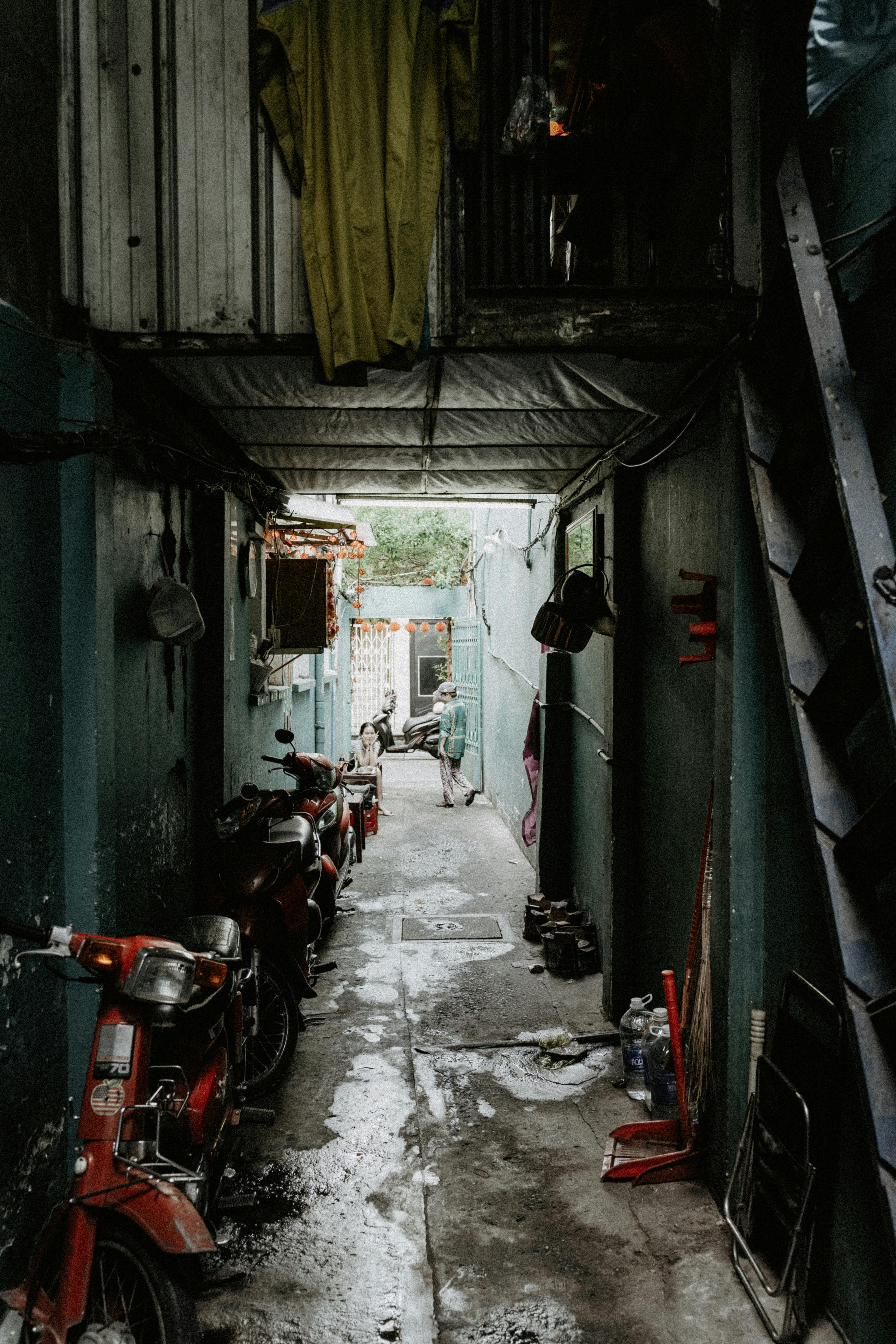 A narrow alley with motorcycles parked in it · Free Stock Photo