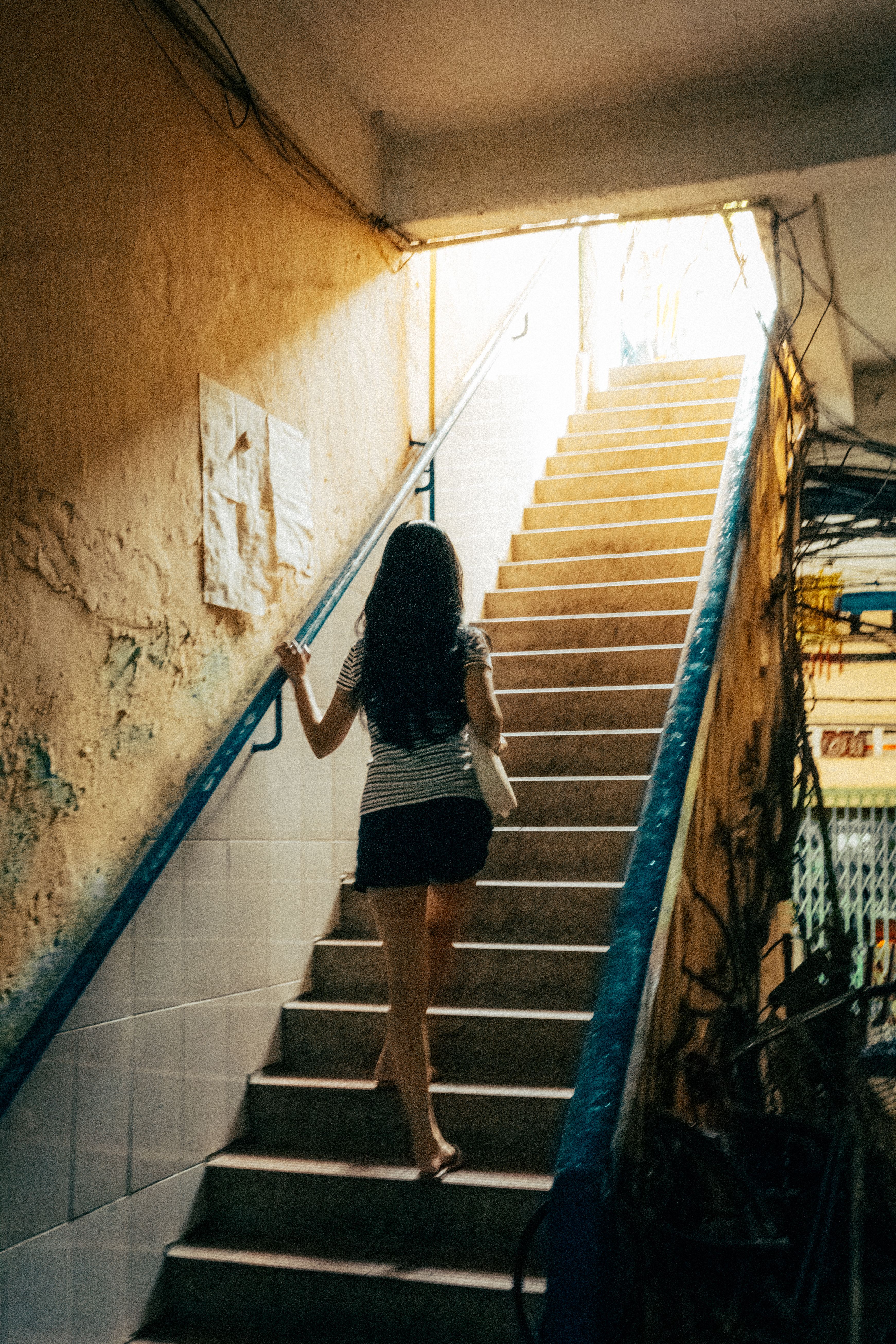 Woman with Long Hair Standing on Stairs · Free Stock Photo