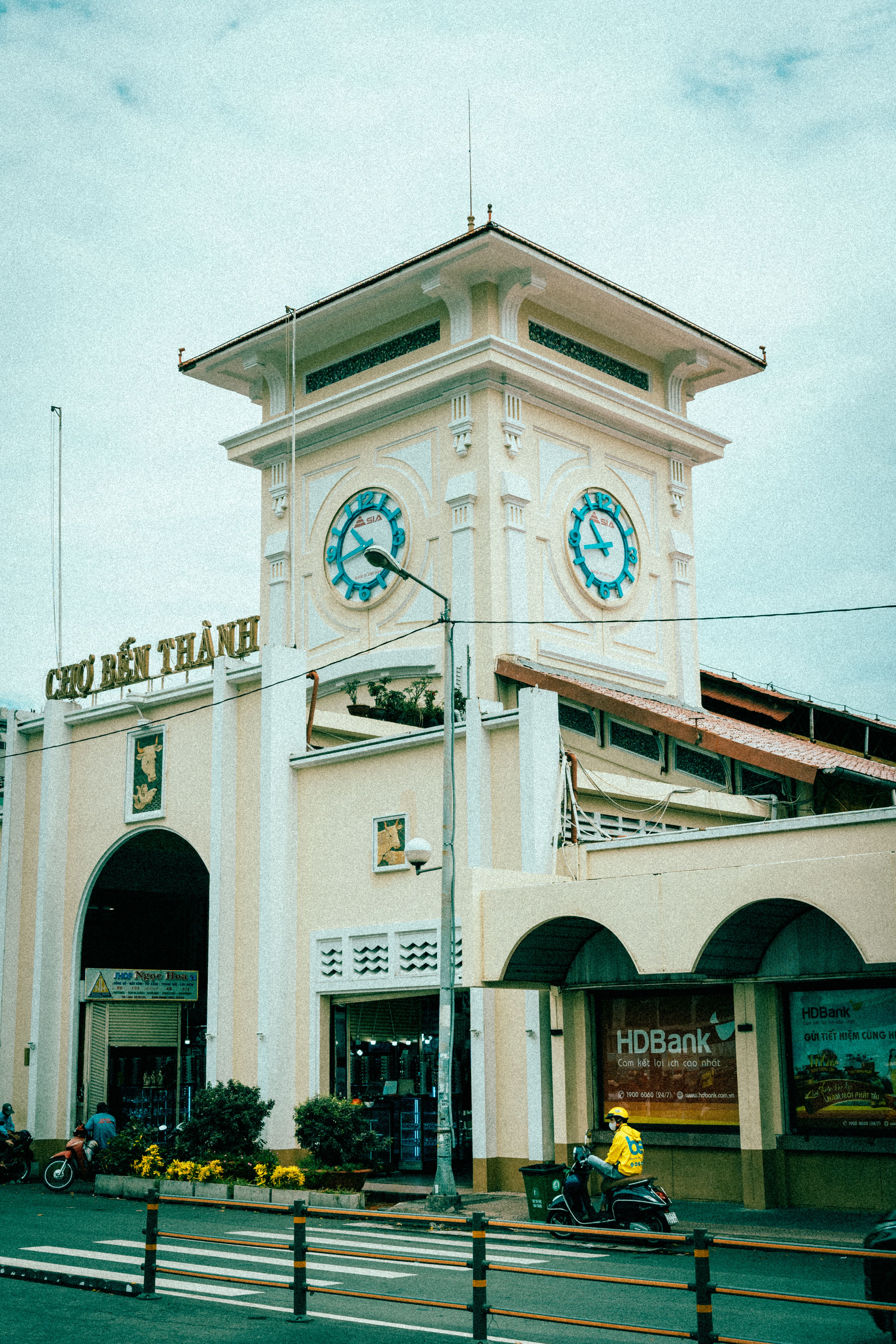 A clock tower with a clock on it sitting on a street · Free Stock Photo