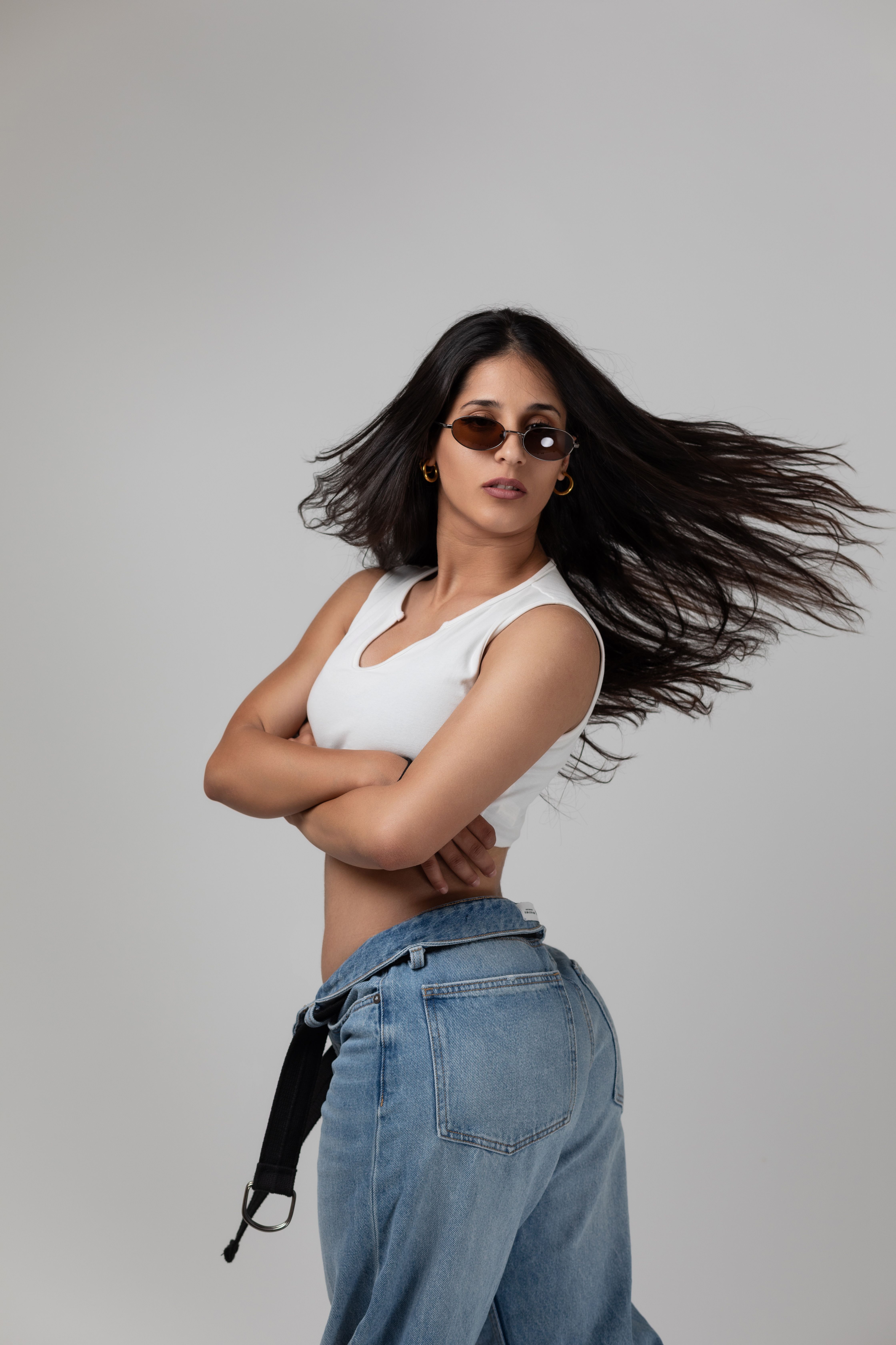 Model Wearing a Crop Top and Jeans · Free Stock Photo