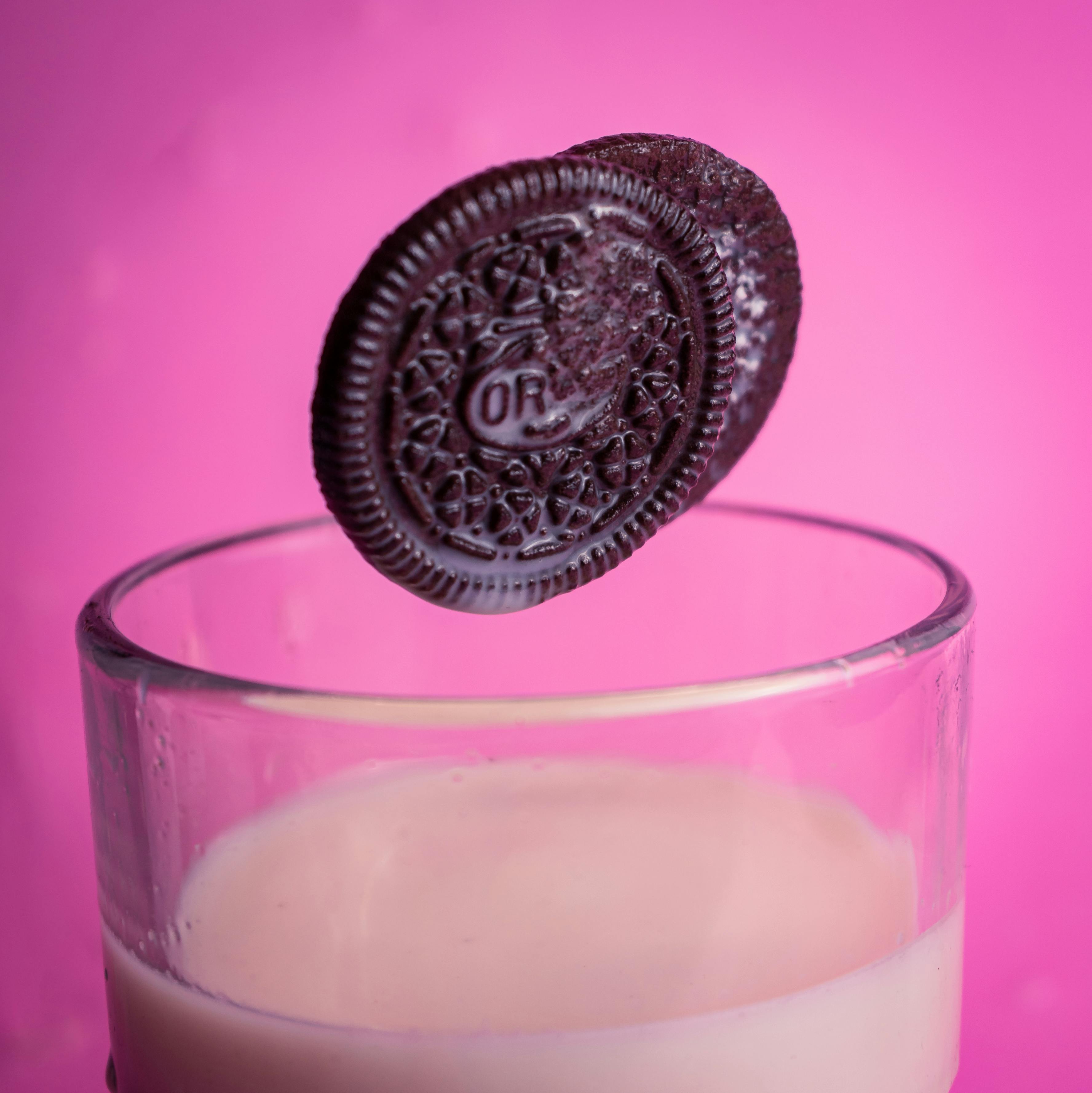 A glass of milk with an oreo cookie floating in it · Free Stock Photo