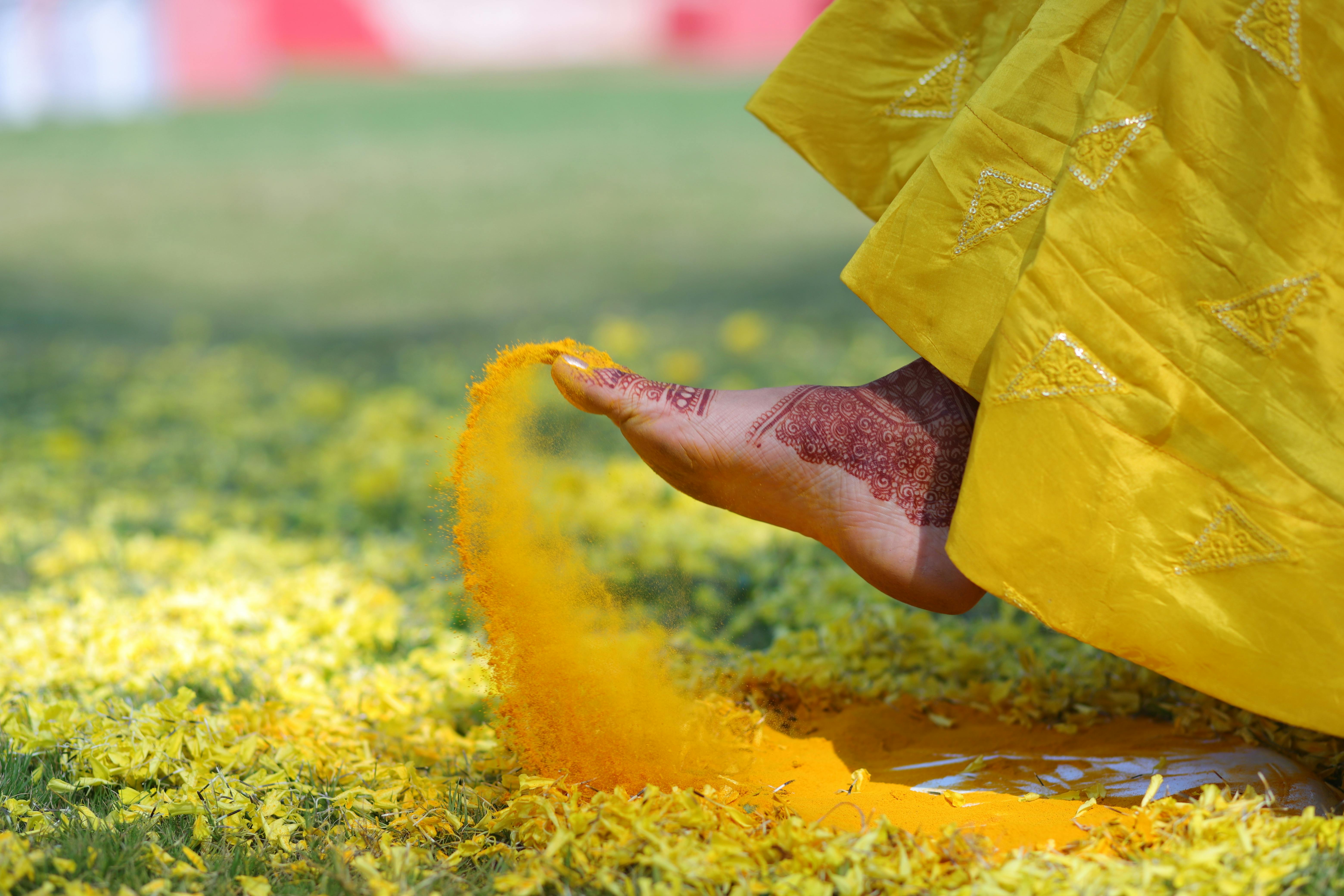 Close-up of a Woman Stepping Her Foot into the Haldi Powder · Free ...