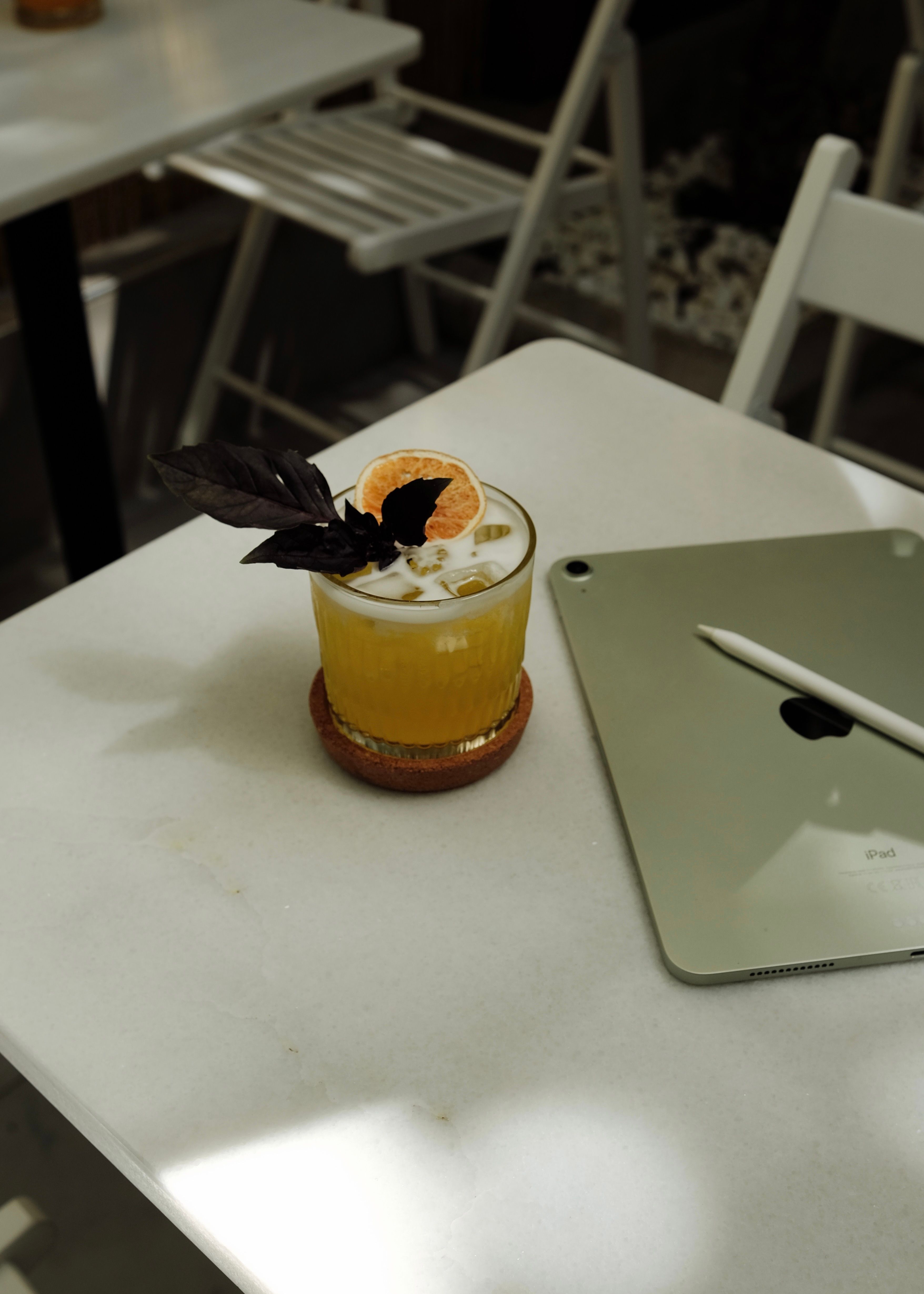 Cocktail with an Orange Slice and Ice Cubes Next to a Tablet · Free ...