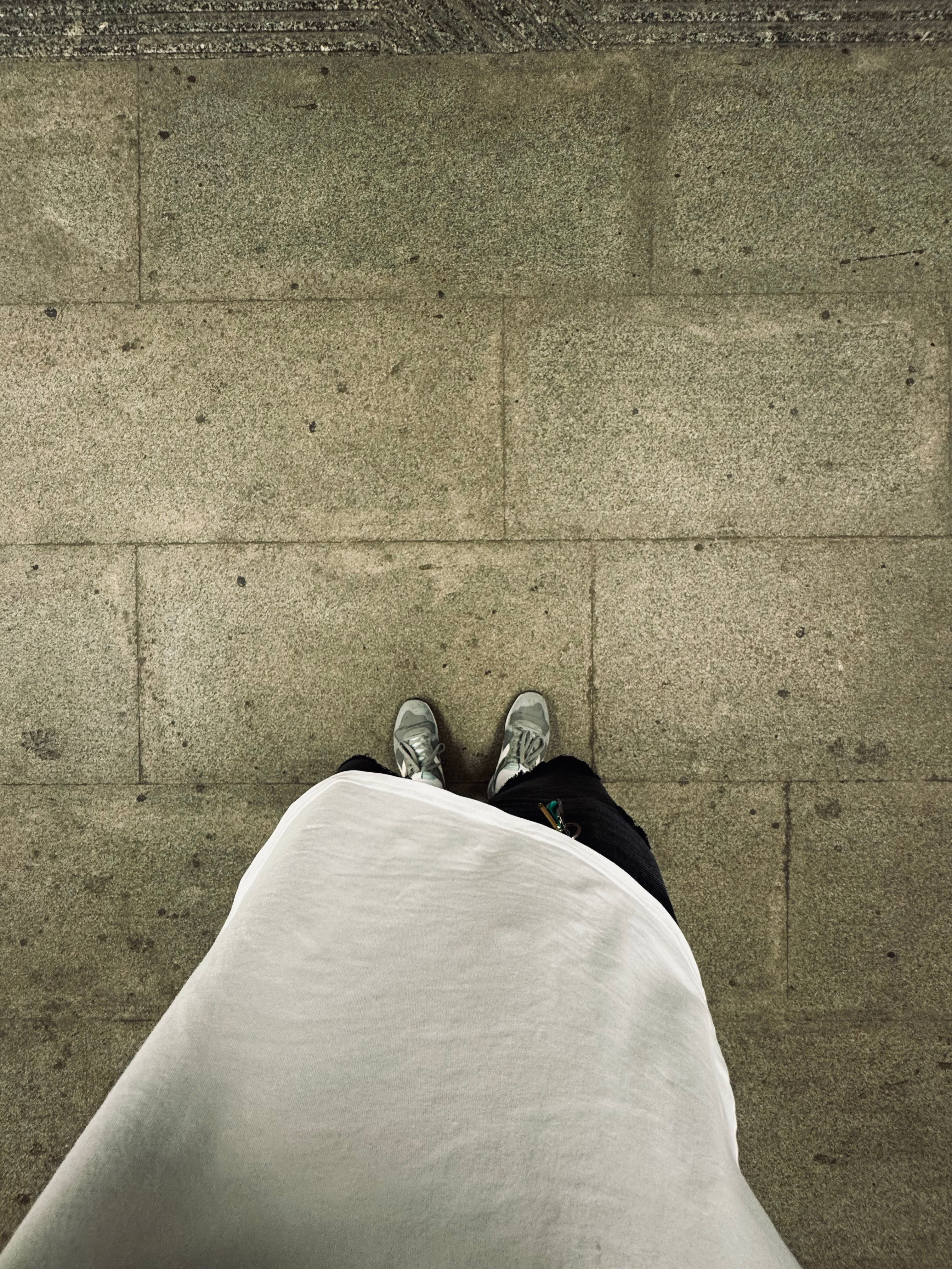 Person Standing on Pavement from Above · Free Stock Photo