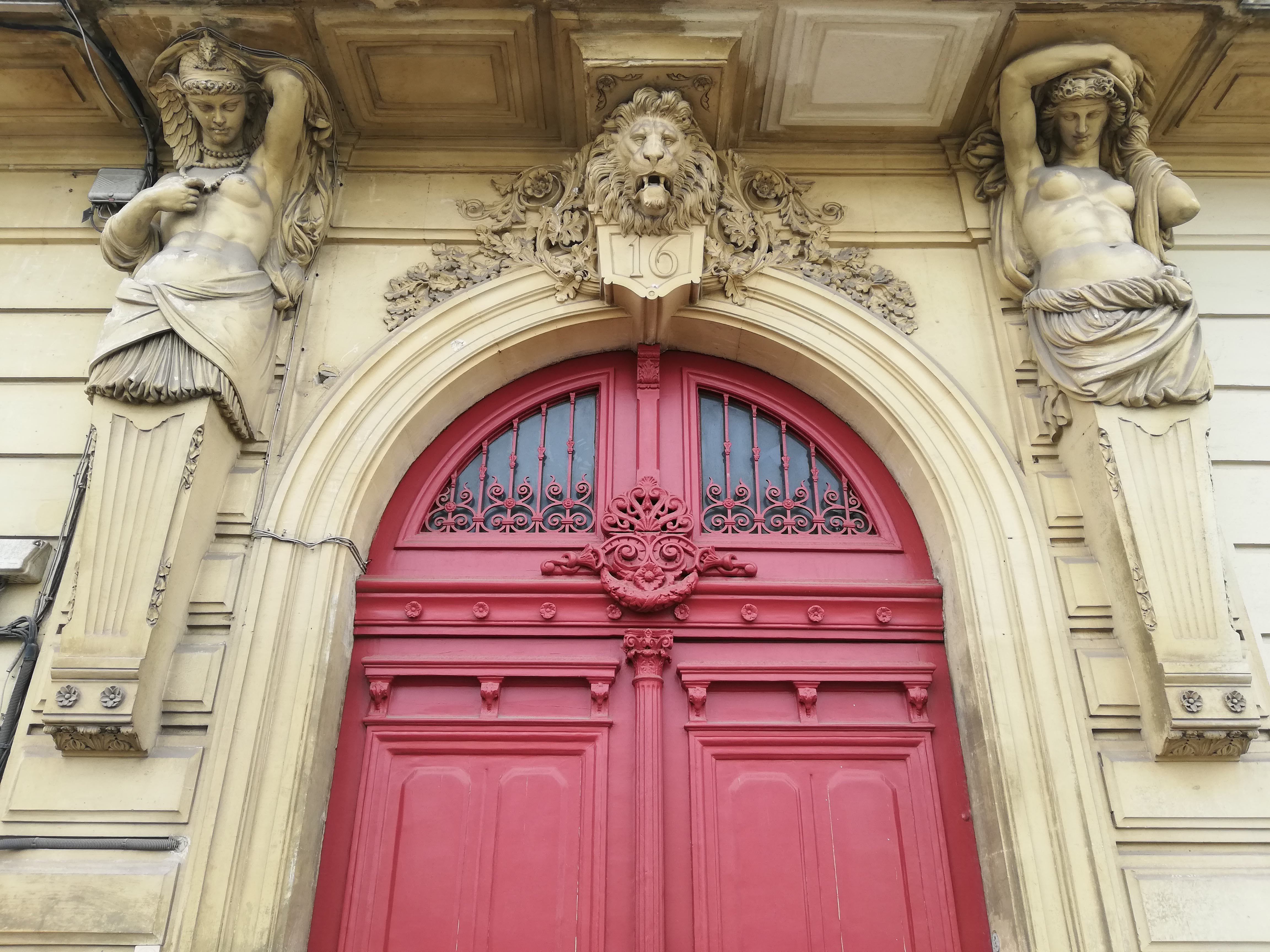 Sculptures over a Red Entrance Gate · Free Stock Photo