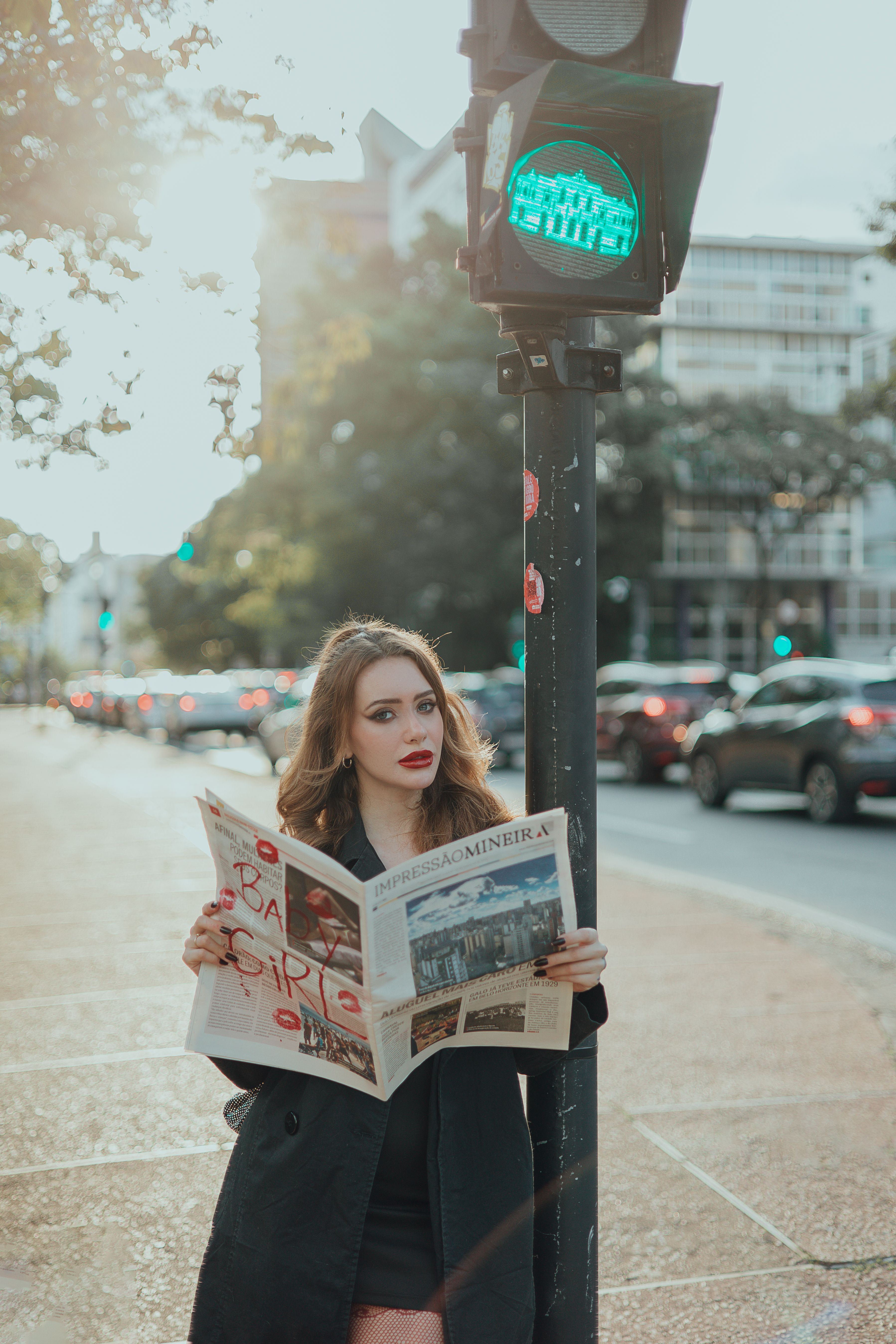 Beautiful Woman Holding a Newspaper Posing · Free Stock Photo
